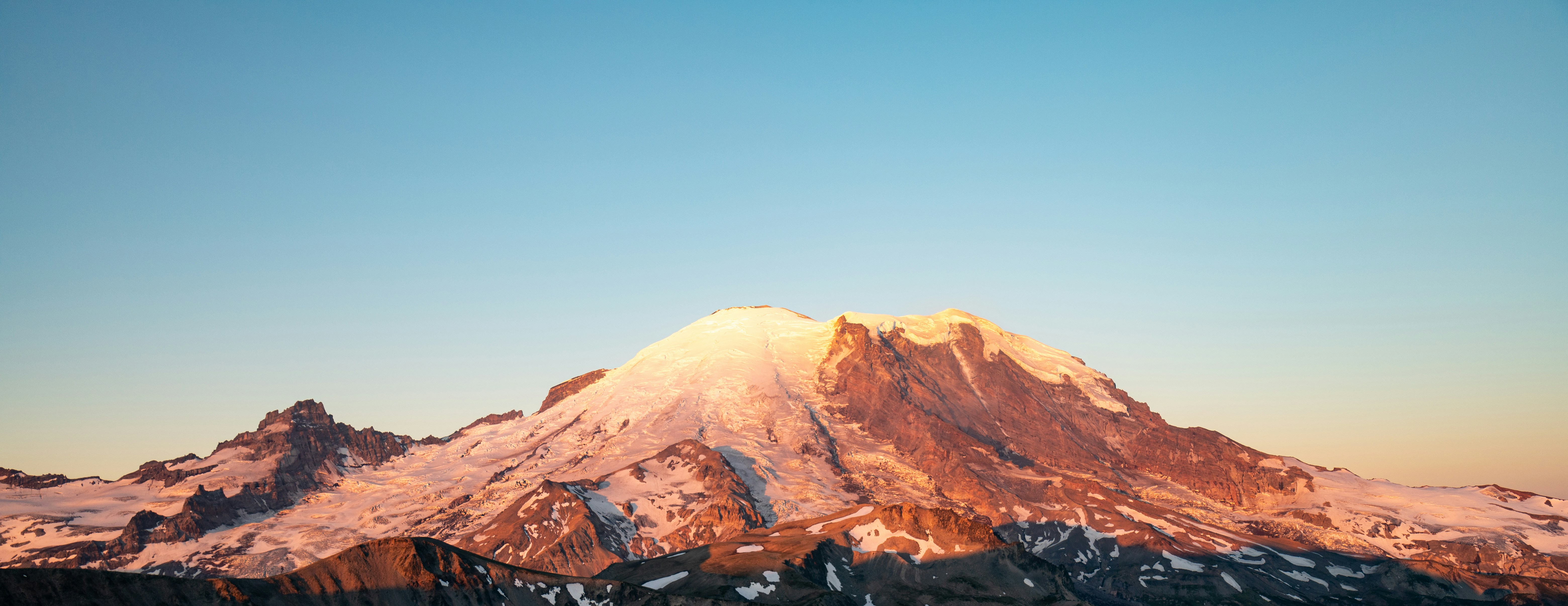A snow covered mountain with a blue sky in the background photo – Free Mount rainier national ...