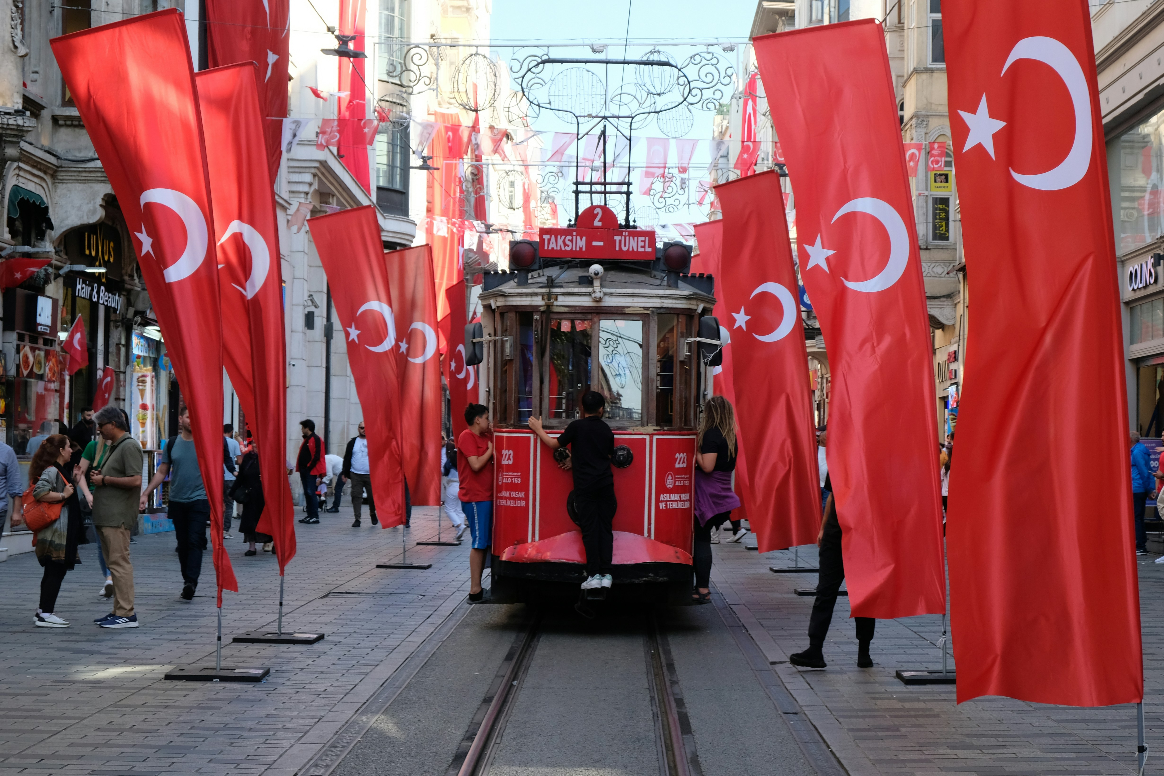 A trolley car on a street with flags on it photo – Free Türkiye Image ...