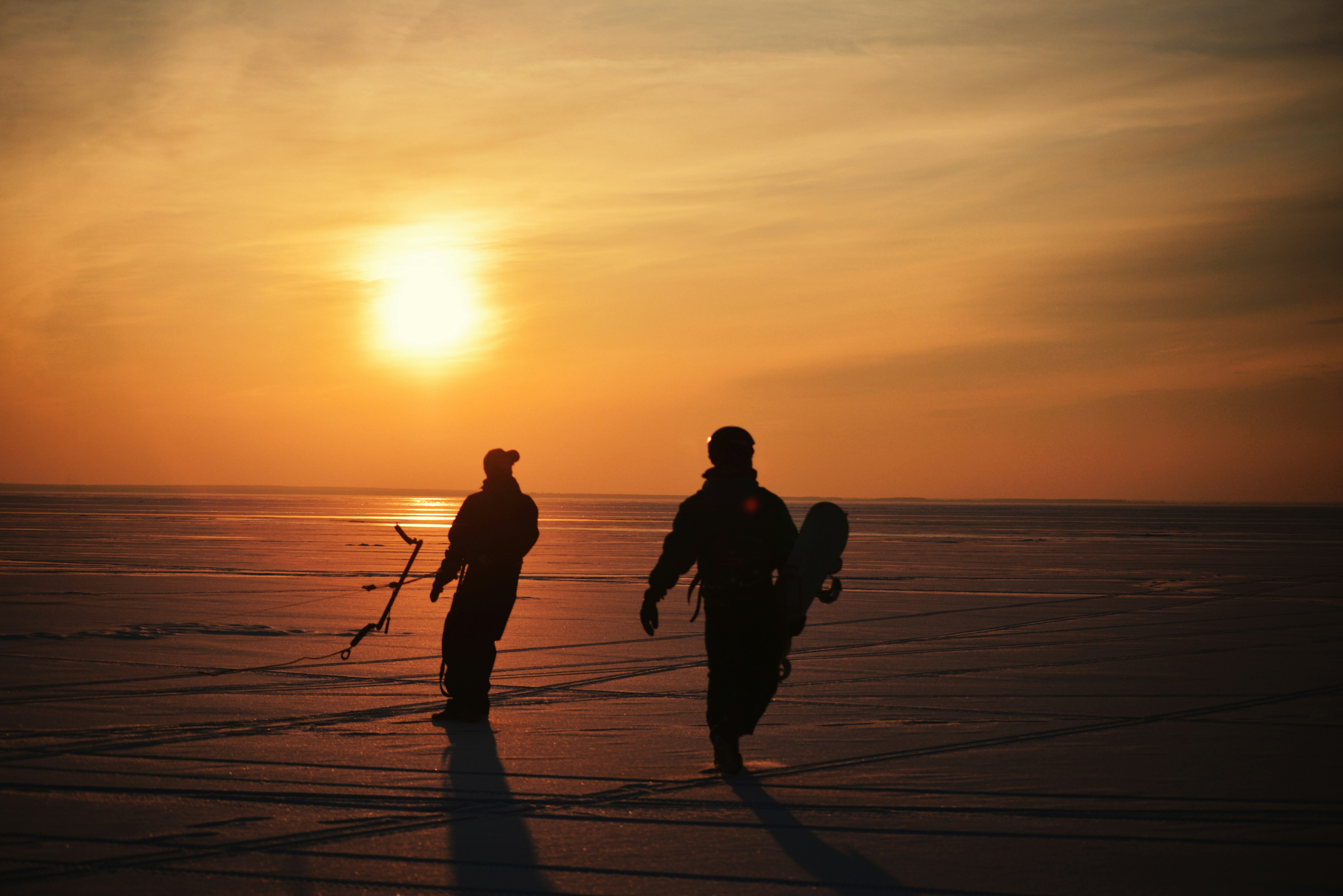 Sunlit Silence: Silhouetted Explorers Across a Frozen Horizon