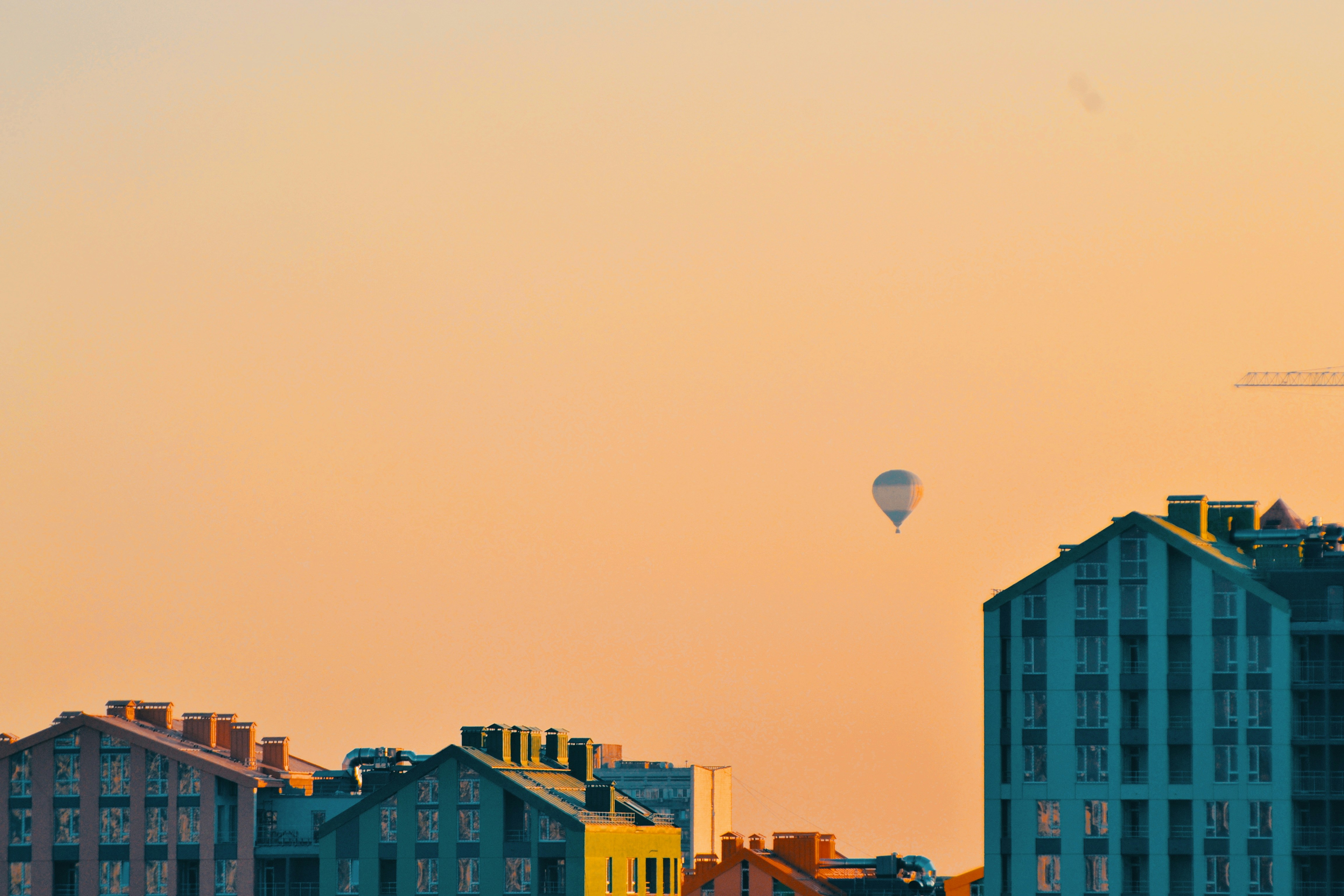 a hot air balloon flying over a city