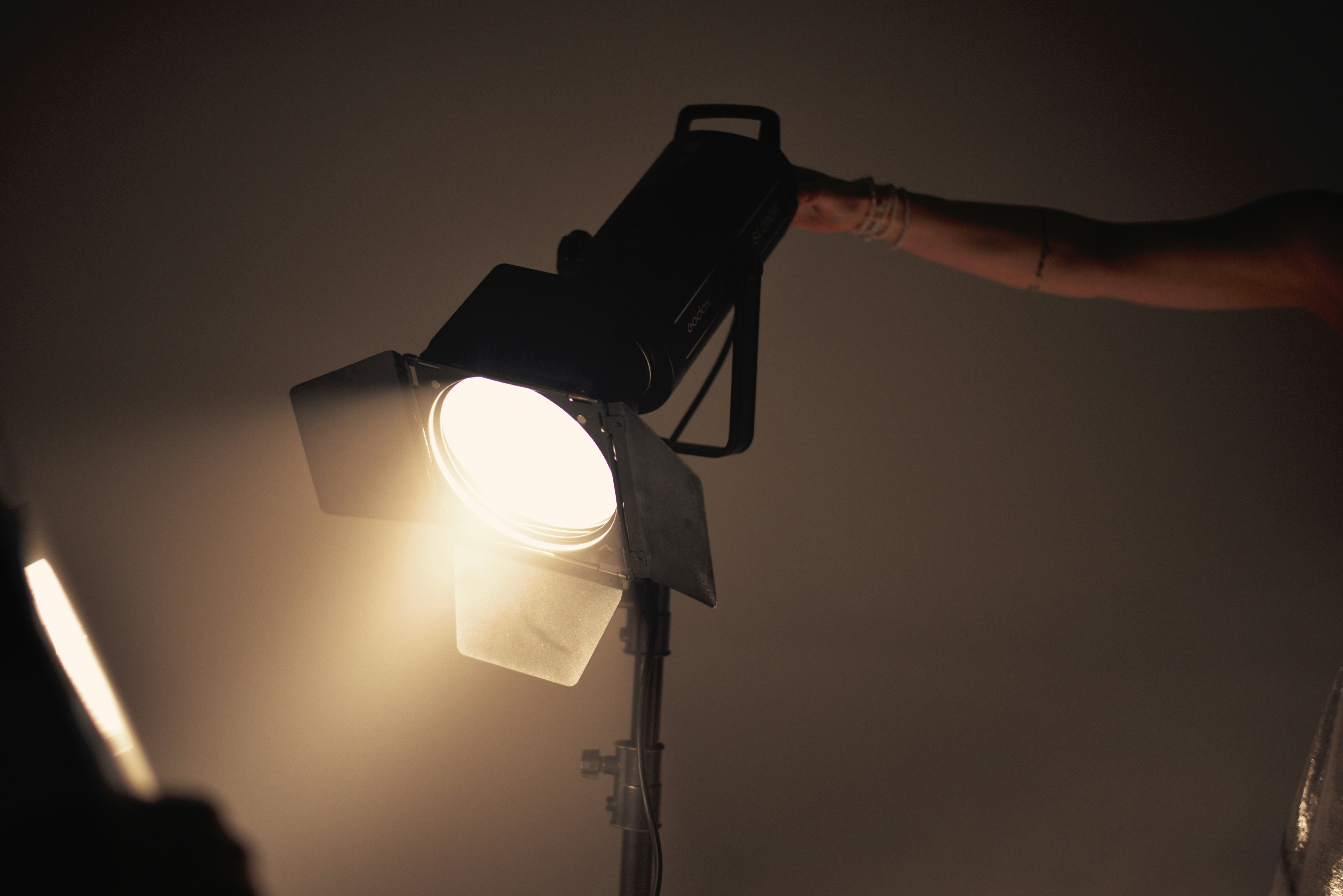 Backlit Studio Spotlight: A Hand Reaches for the Beam