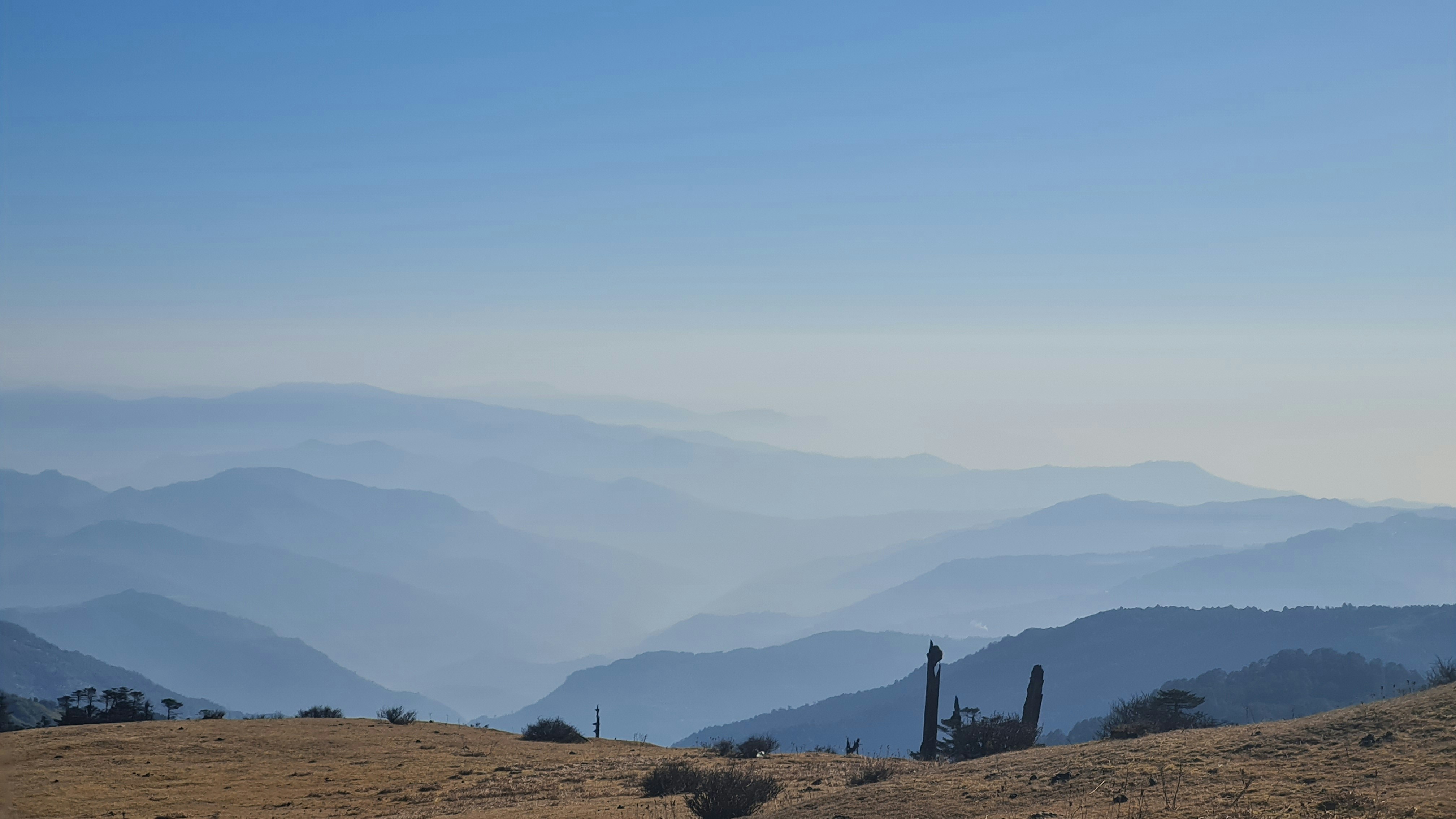 Blue Haze Over the Golden Foothills: Quiet Ridges in Distant Light