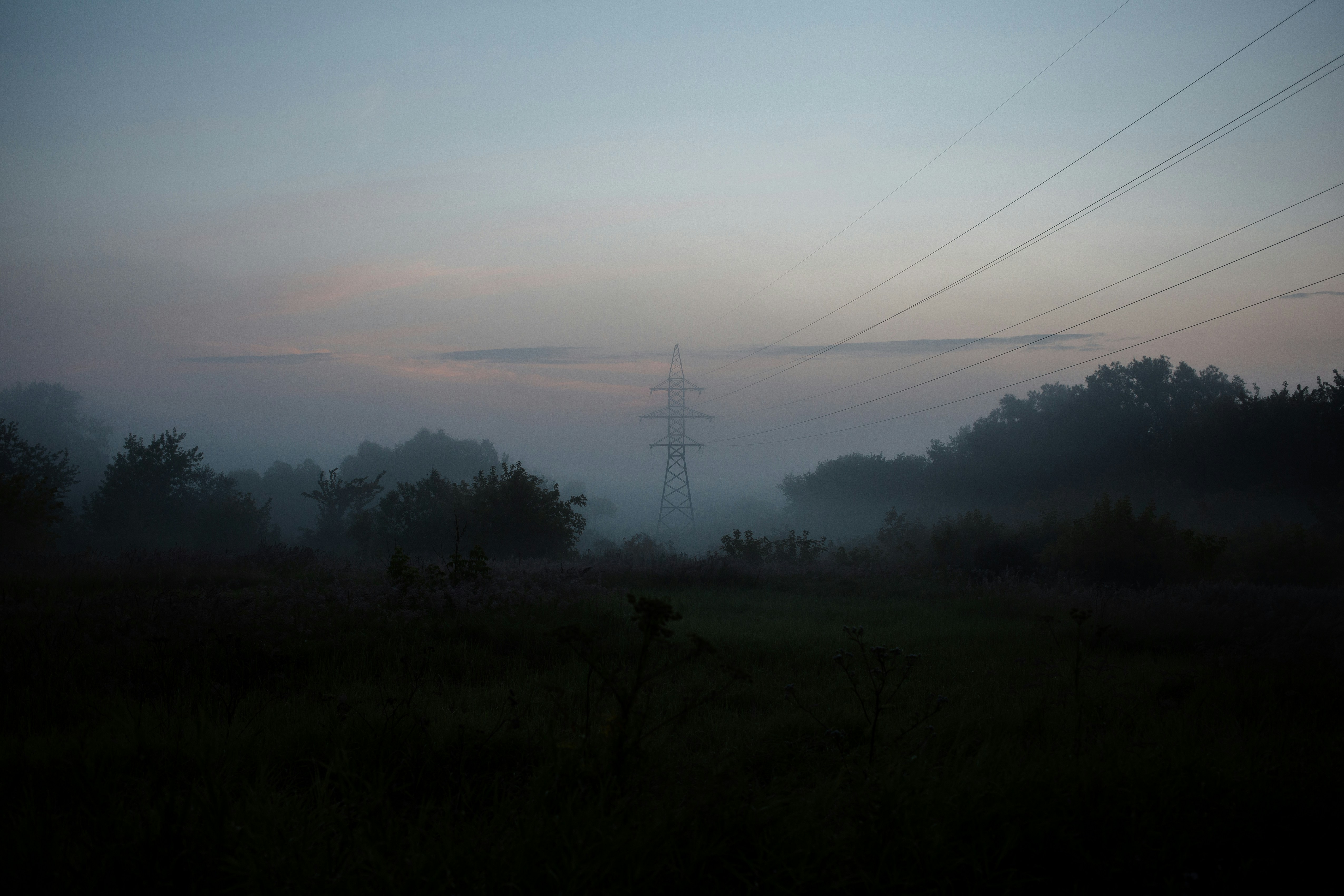 A foggy field with power lines in the distance photo – Free Travel ...