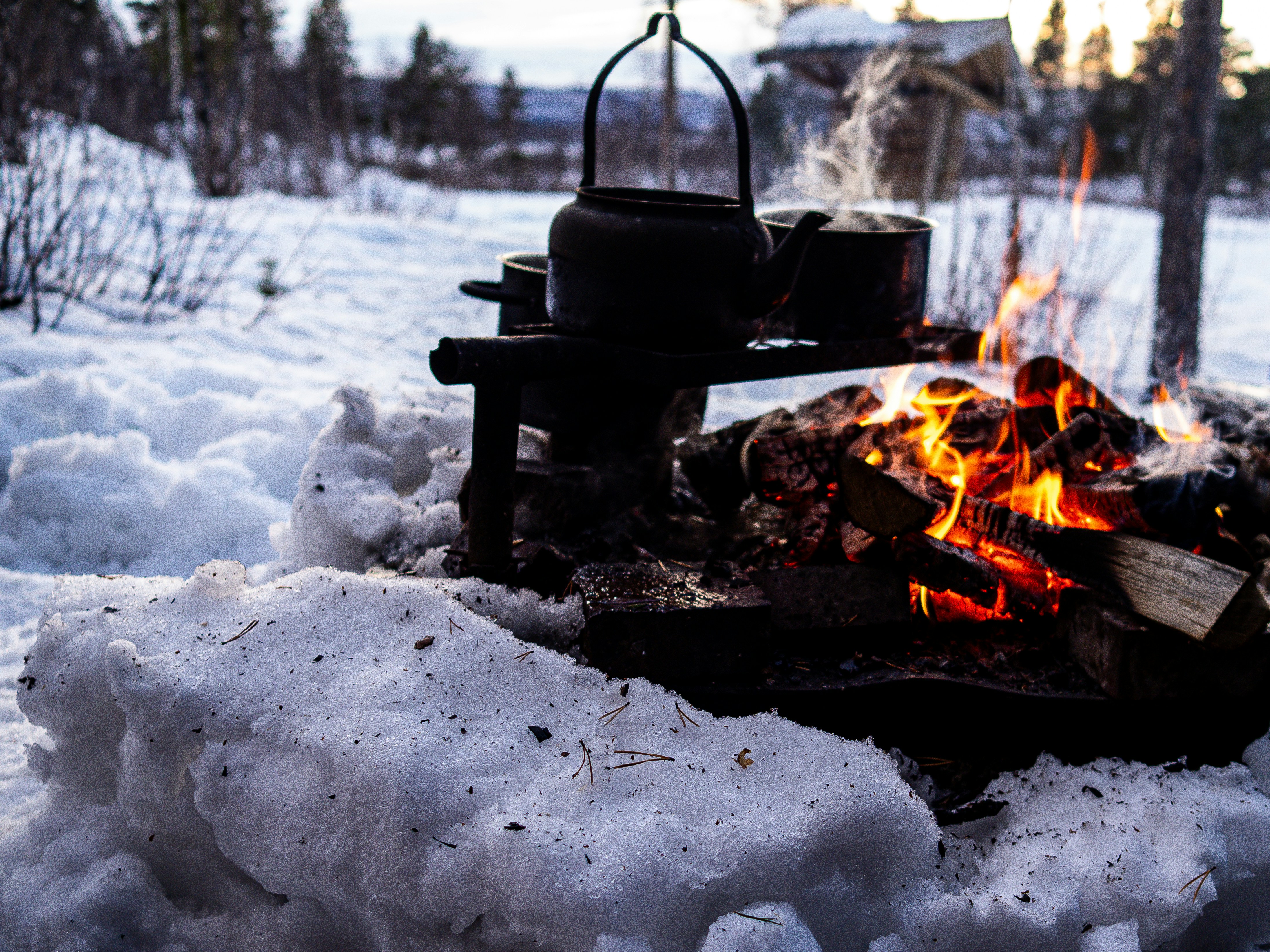 Snowbound Campfire Kitchen: A Kettle Simmering Over Coals.
