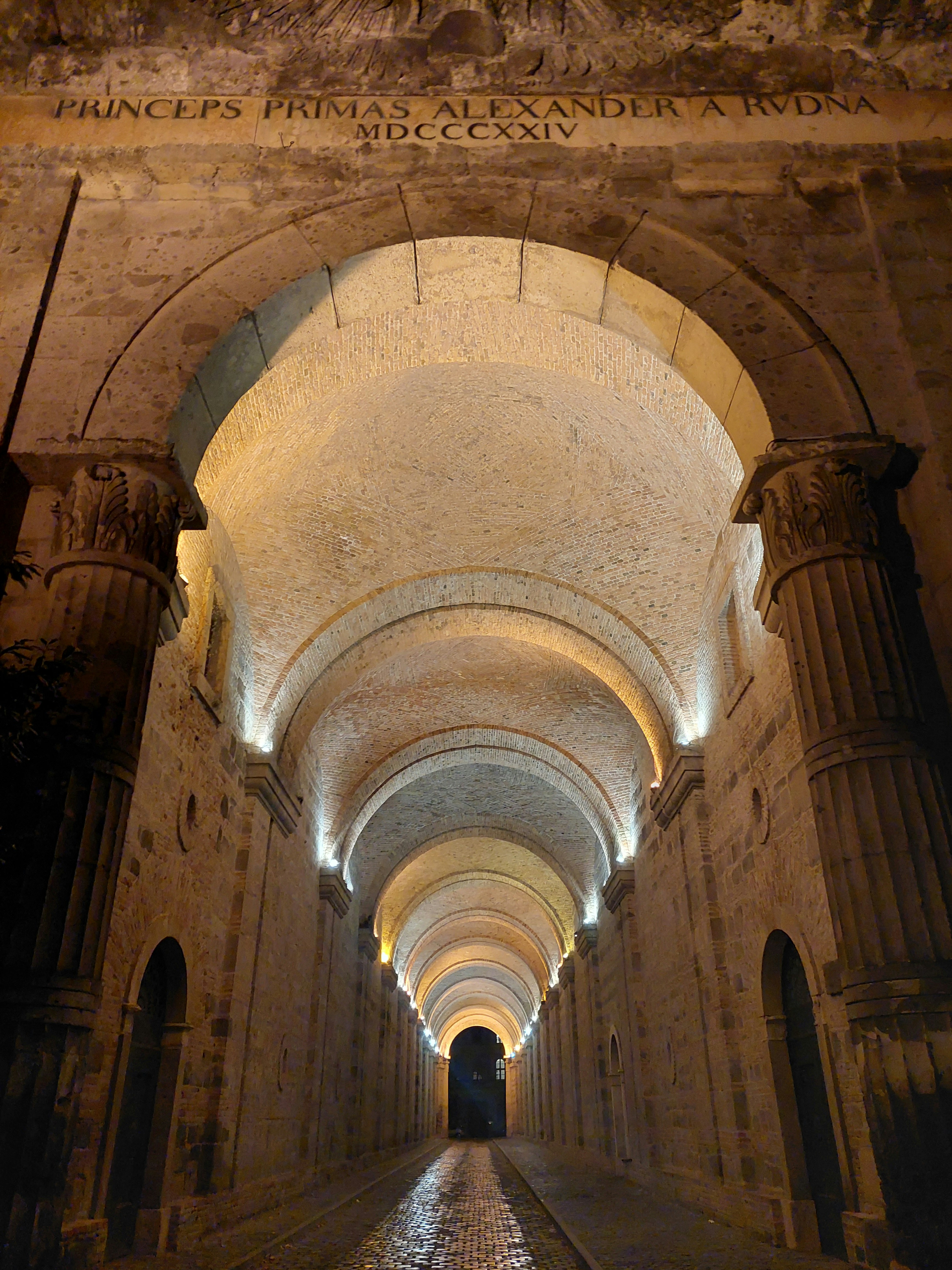 Arcade of Echoes: Lantern-lit Cloister Receding Toward a Distant Light