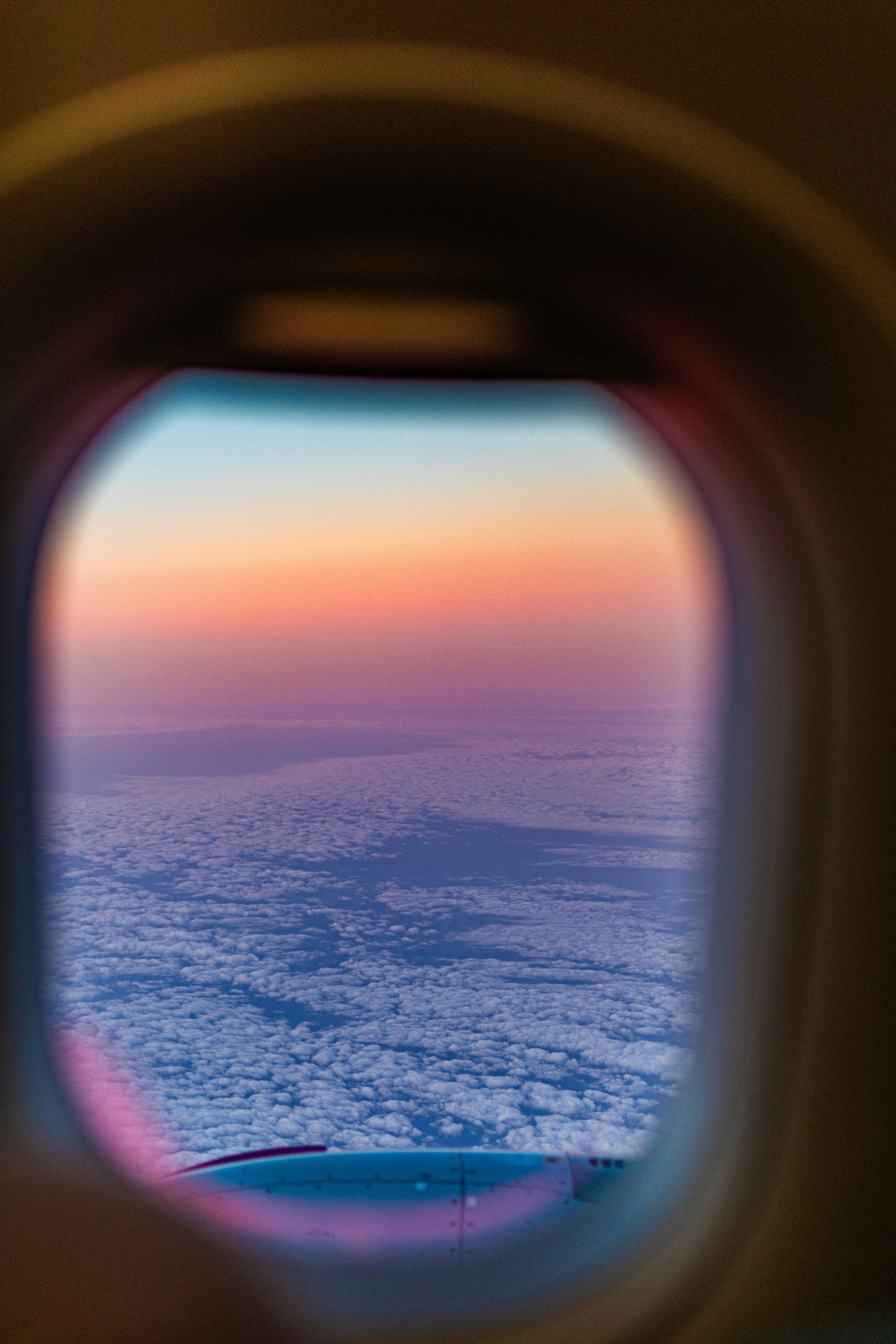 Window to Dusk: Aerial Sunset Over Layered Clouds