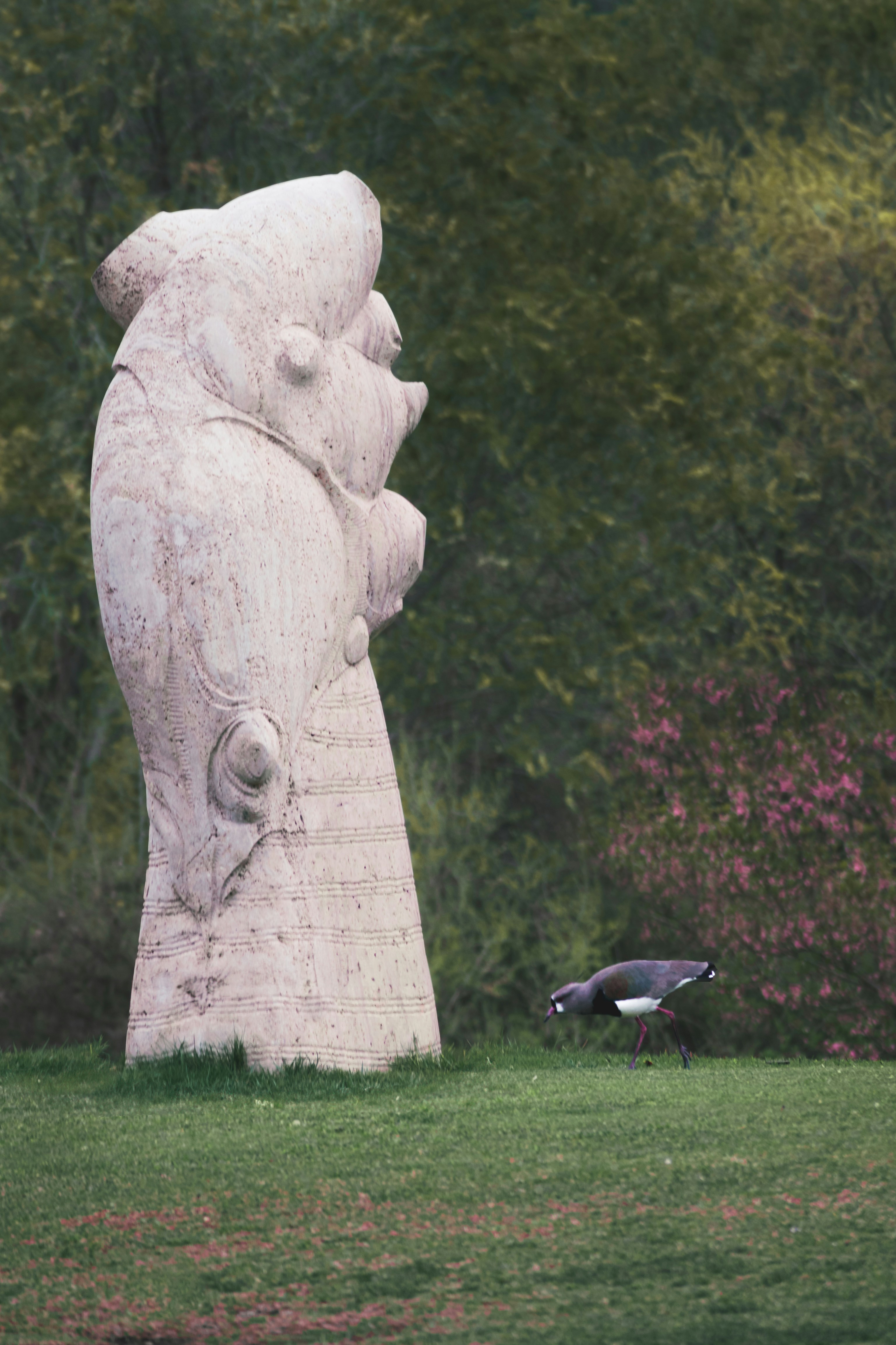 Stone Sentinel Meets a Curious Crane