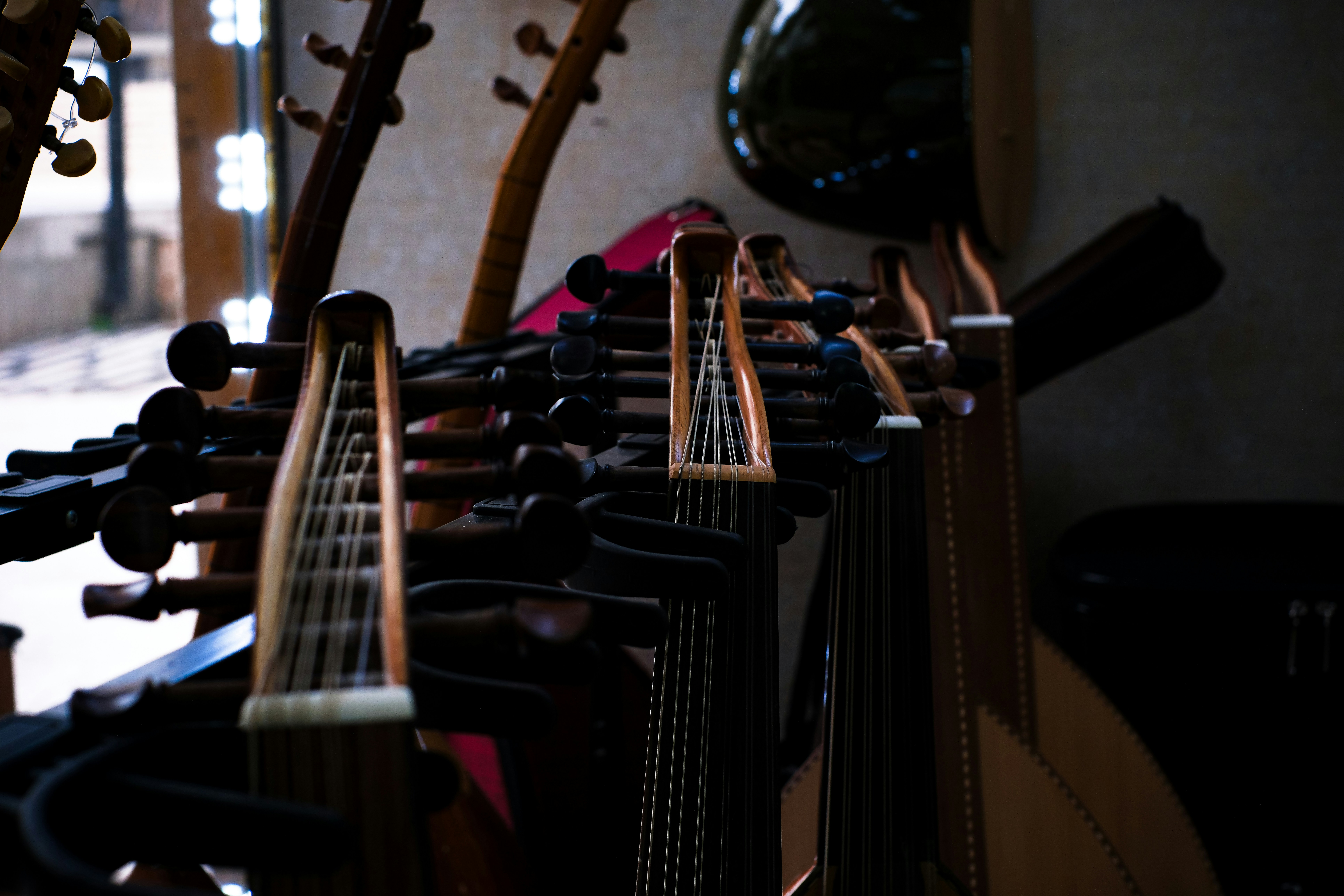 Strings in Focus: A Row of Guitars Packed with Light and Shadow