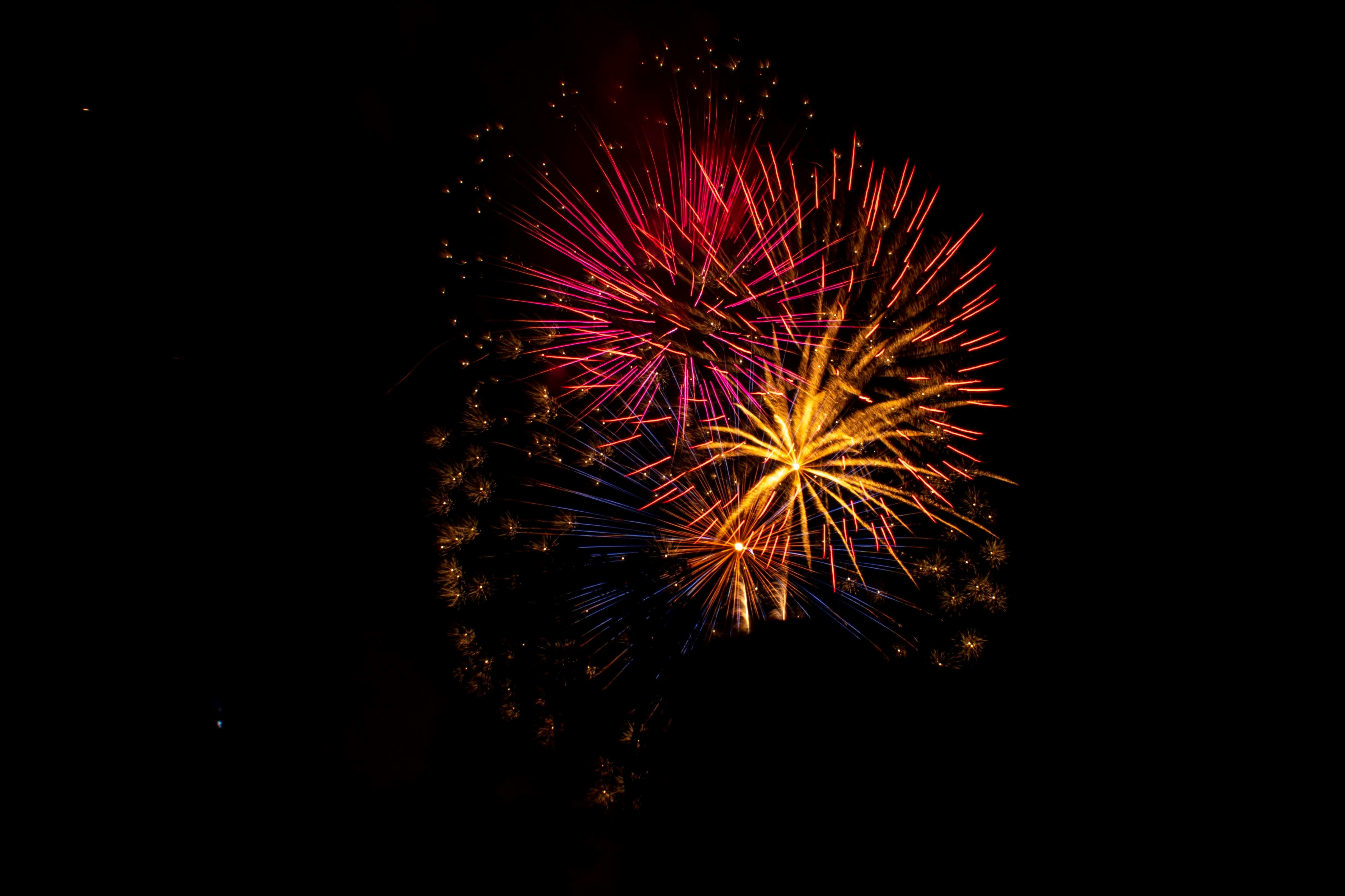 A colorful fireworks is lit up in the night sky photo – Free Fireworks ...
