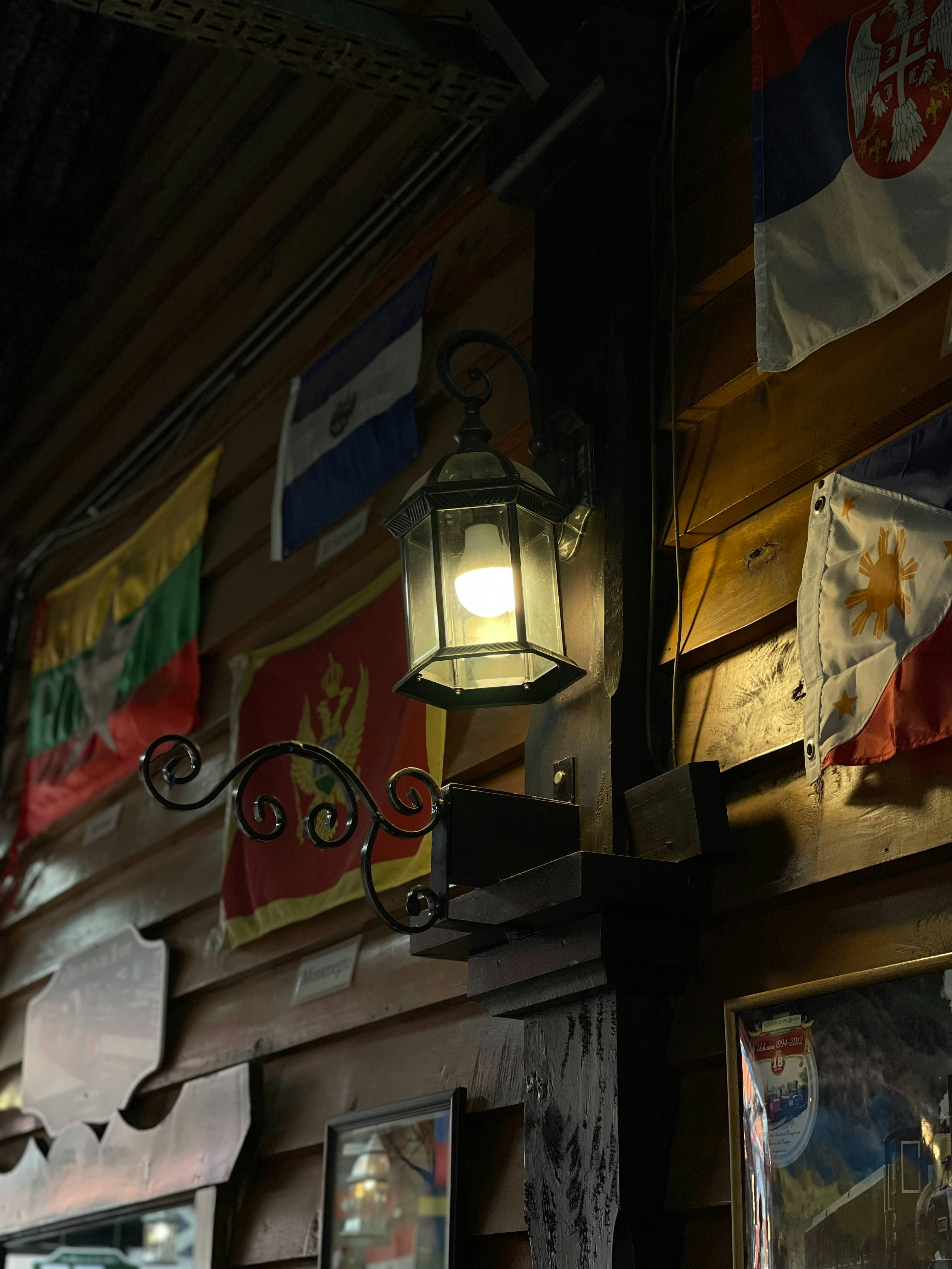 Lantern Glow Framing Flags on a Timber Wall