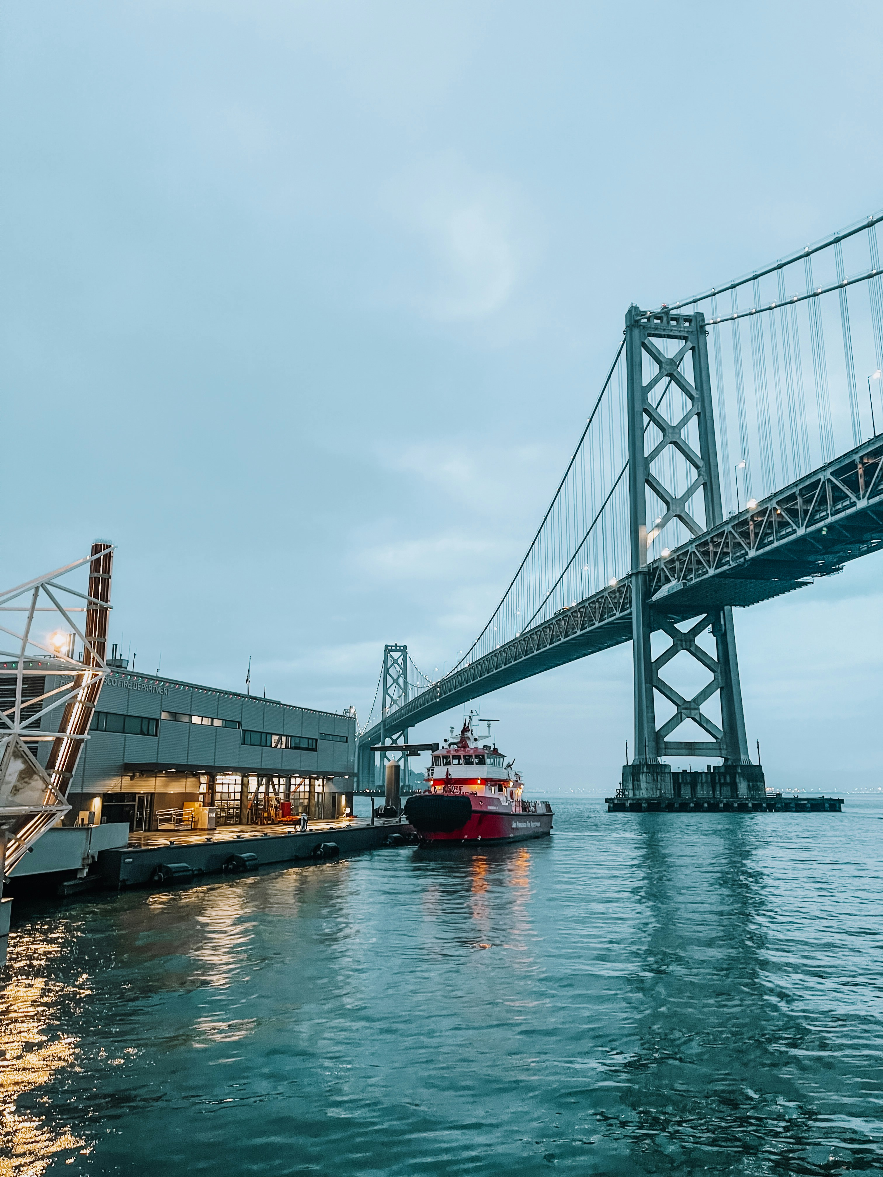 Under a Lattice of Steel: Tug, Pier, and the Bay Bridge