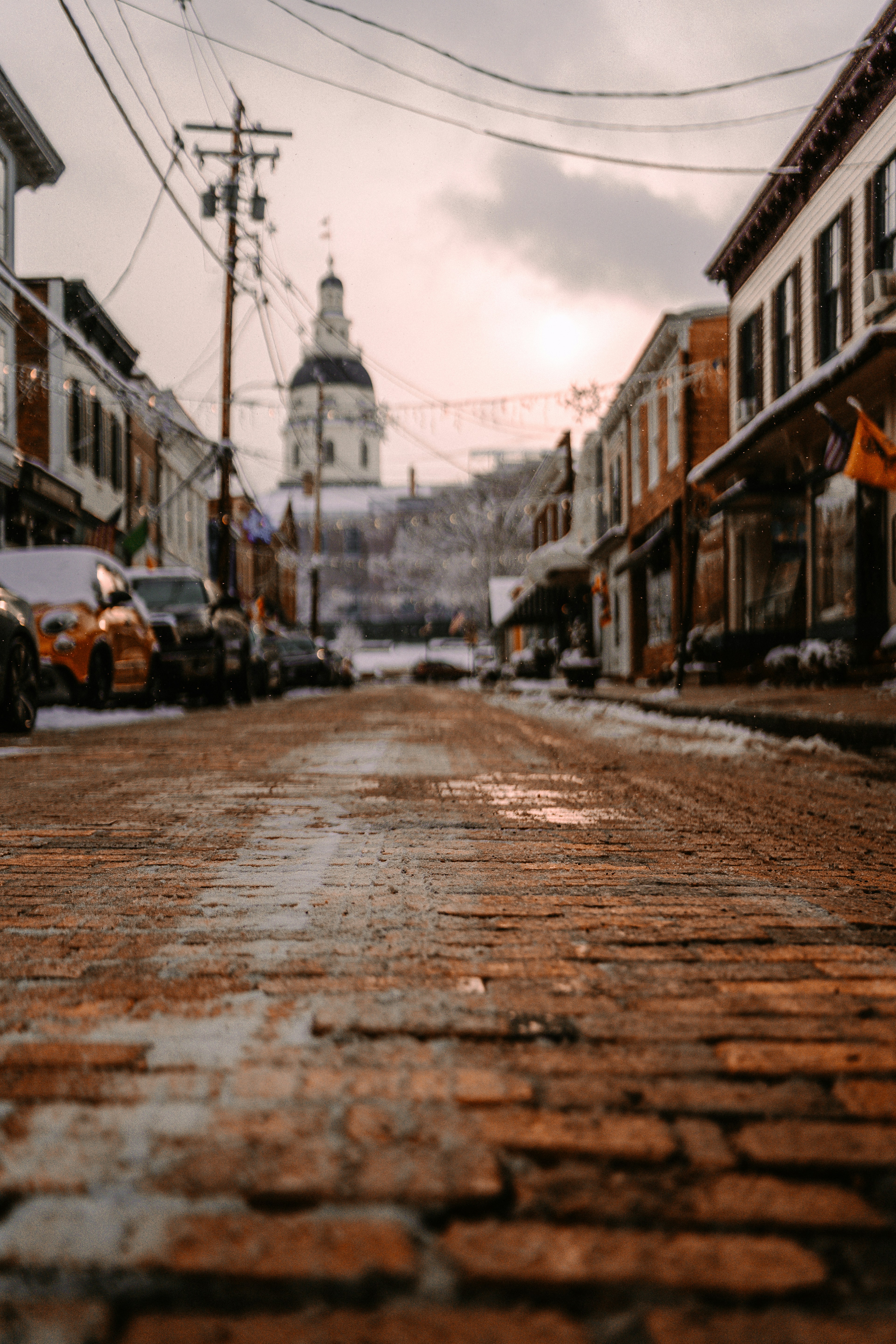 Cobblestone Corridor Toward a Distant Clock Tower at Dusk