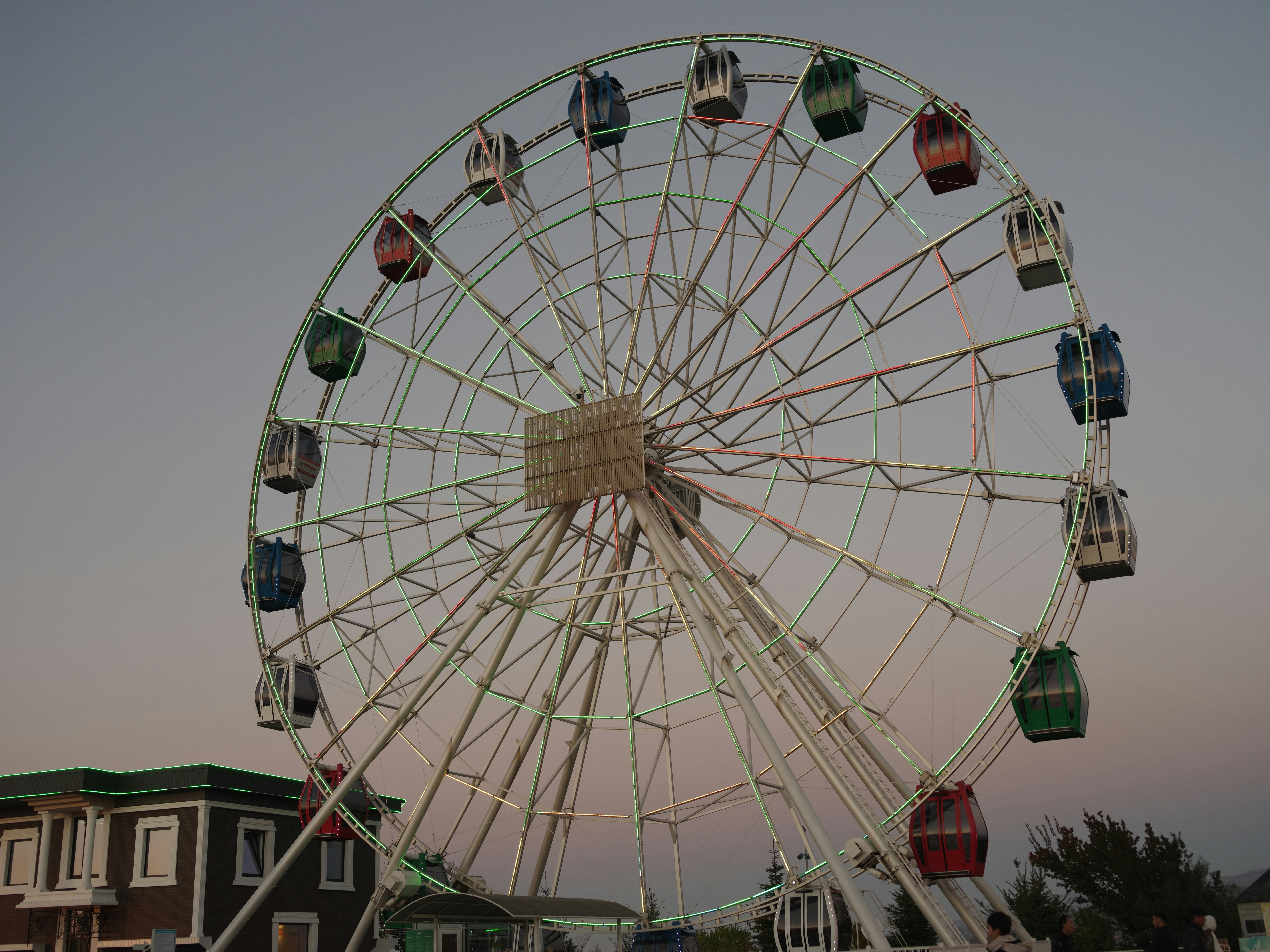 Pastel dusk Ferris wheel: a quiet ride under a fading sky.