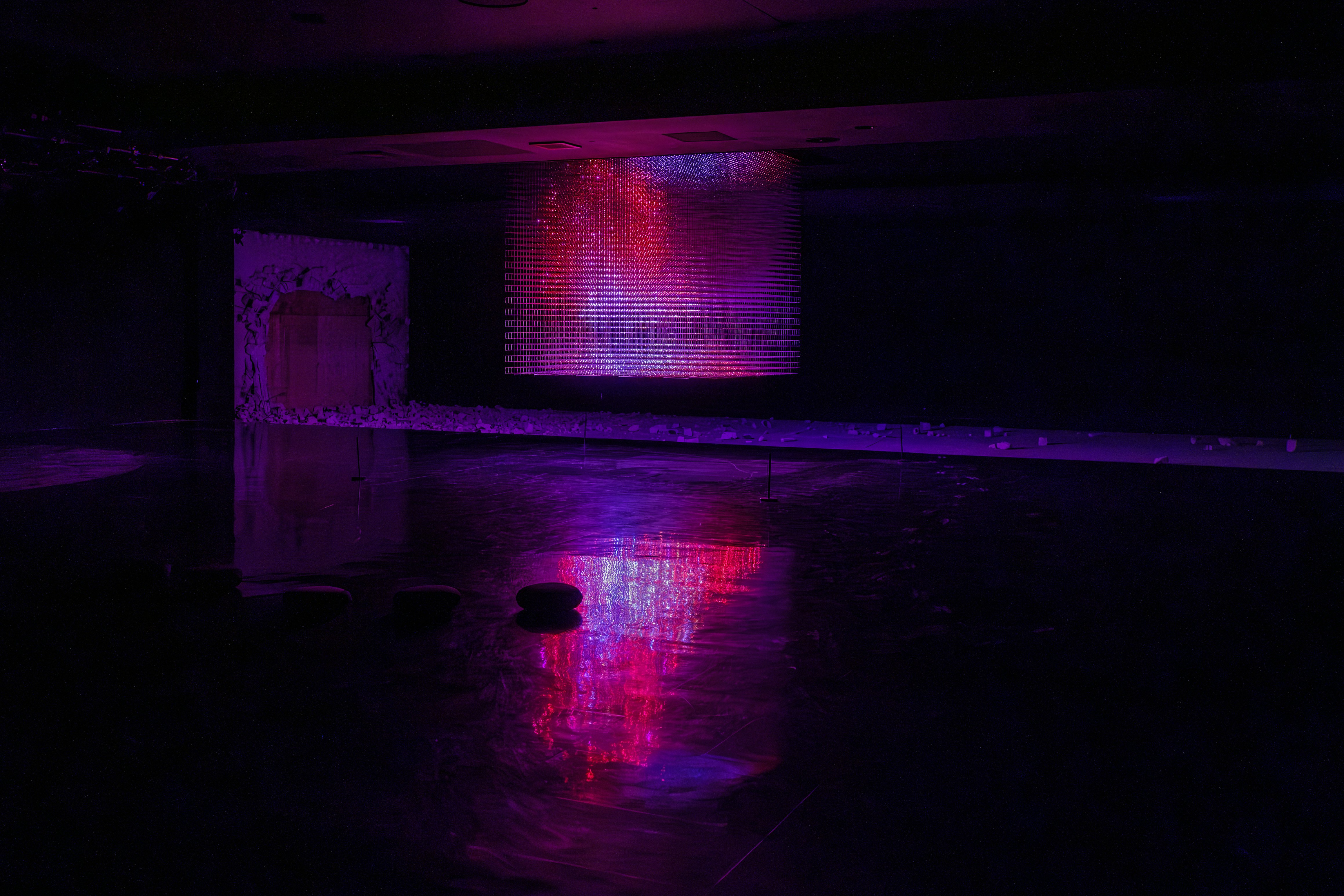A dark room with a purple light reflecting off of the floor photo ...