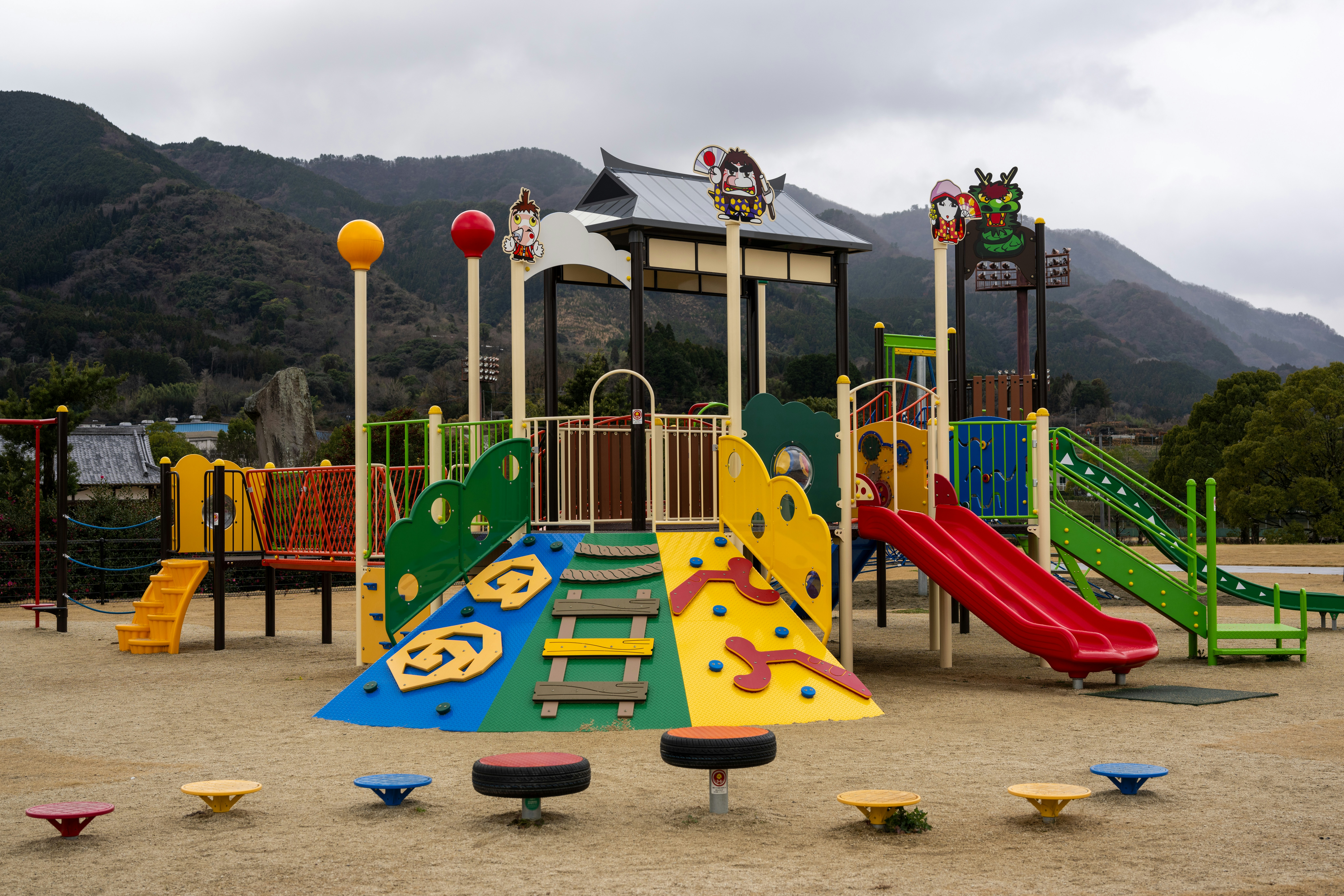 A children's play area with a slide and climbing equipment photo – Free ...