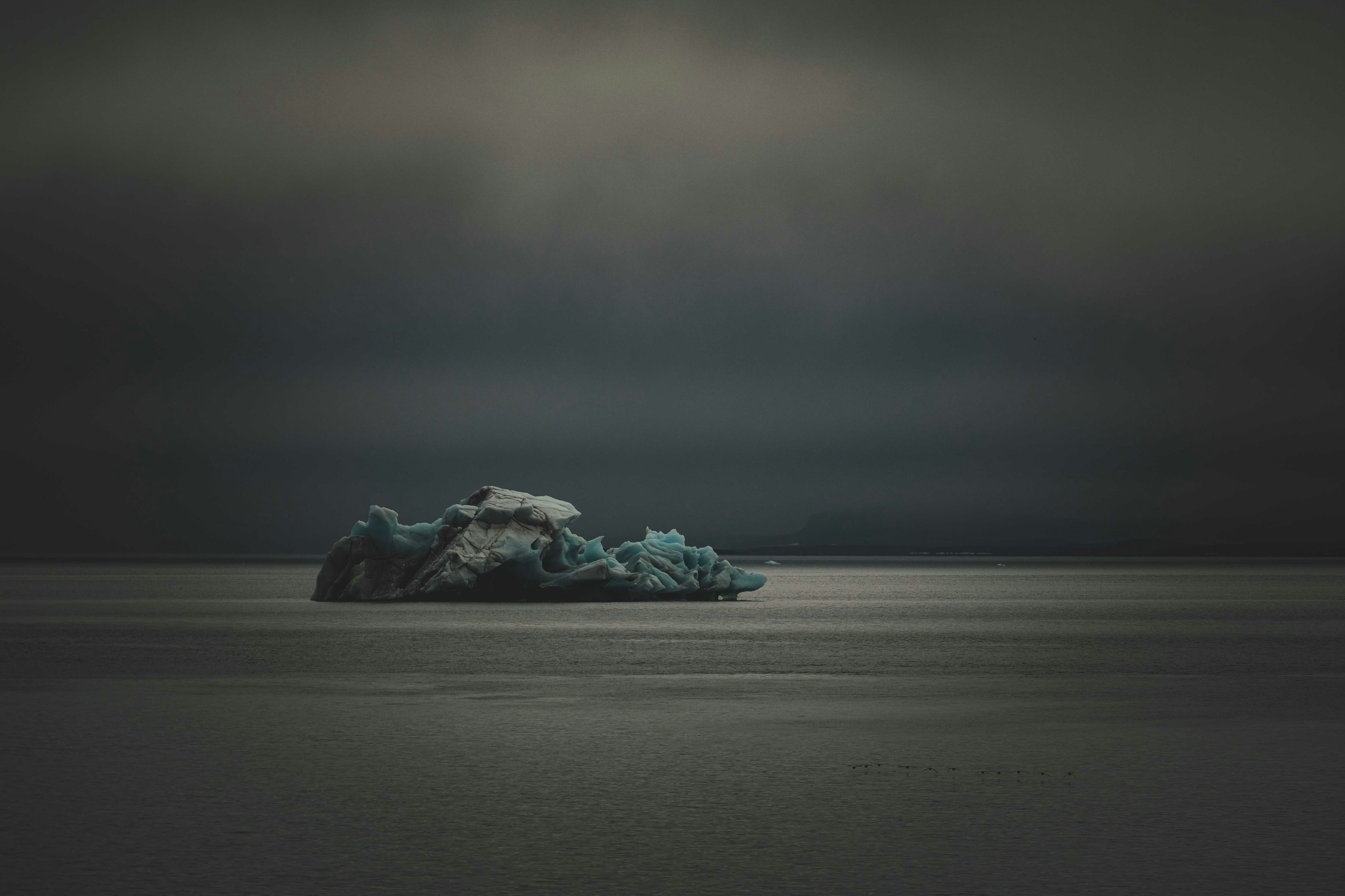 Lone Iceberg Beneath a Moody Arctic Sky