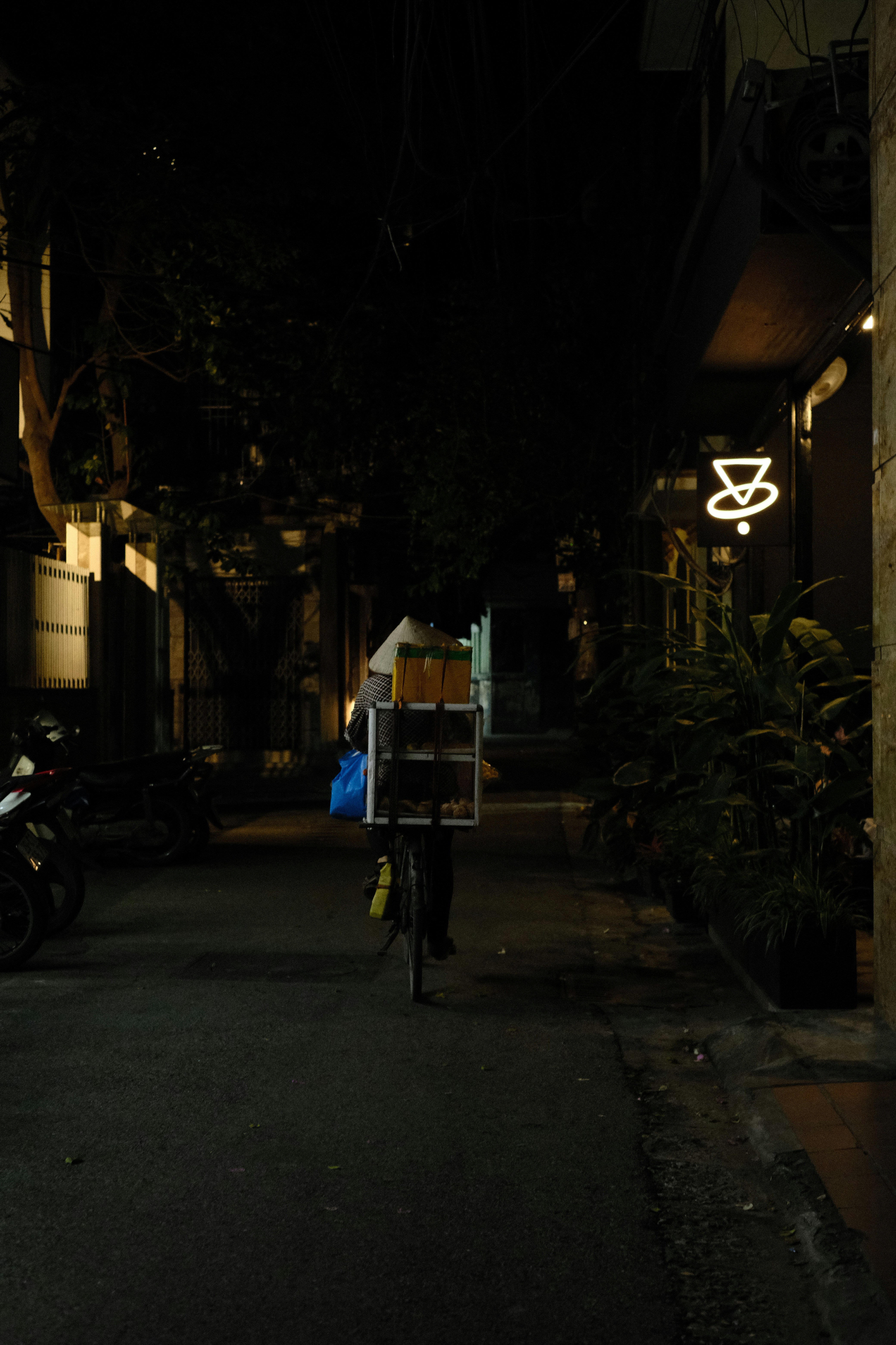 Neon-Glow Alley Cart: A Lone Vendor Pushing Through a Quiet Night Street