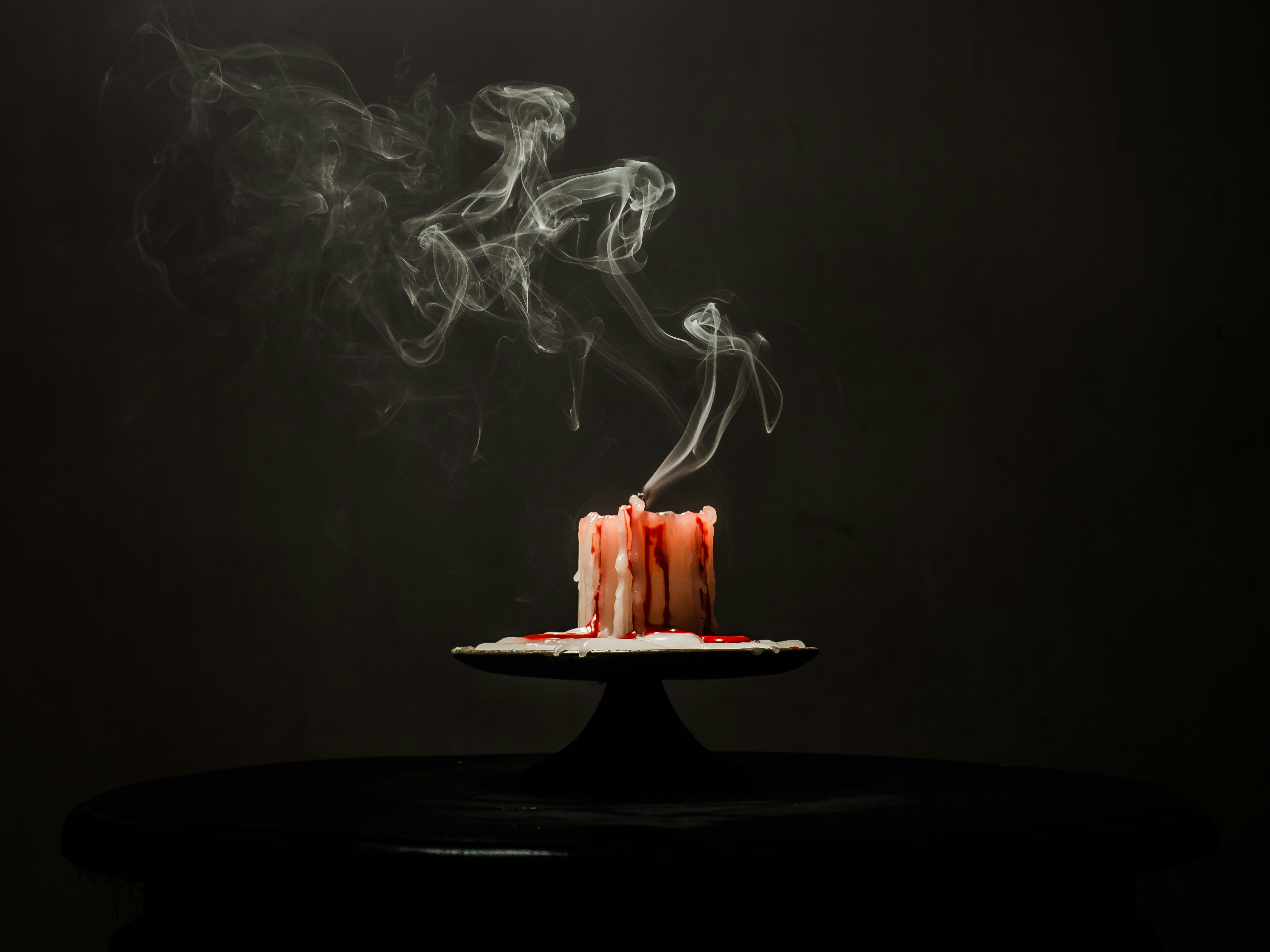 A cake with smoke coming out of it on a plate photo – Free Candle Image ...