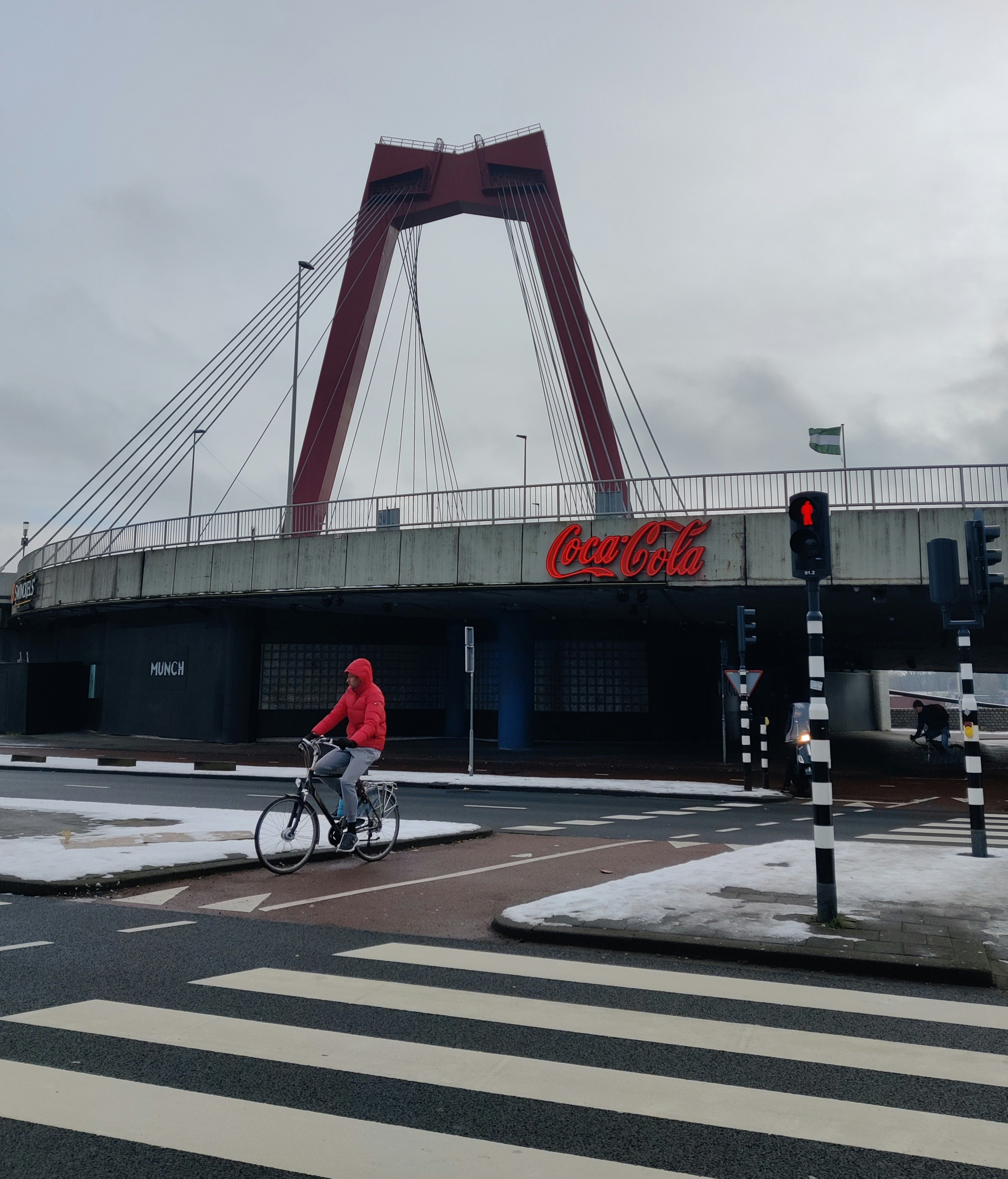 Crimson Arch Framing a Snowy City Crossing