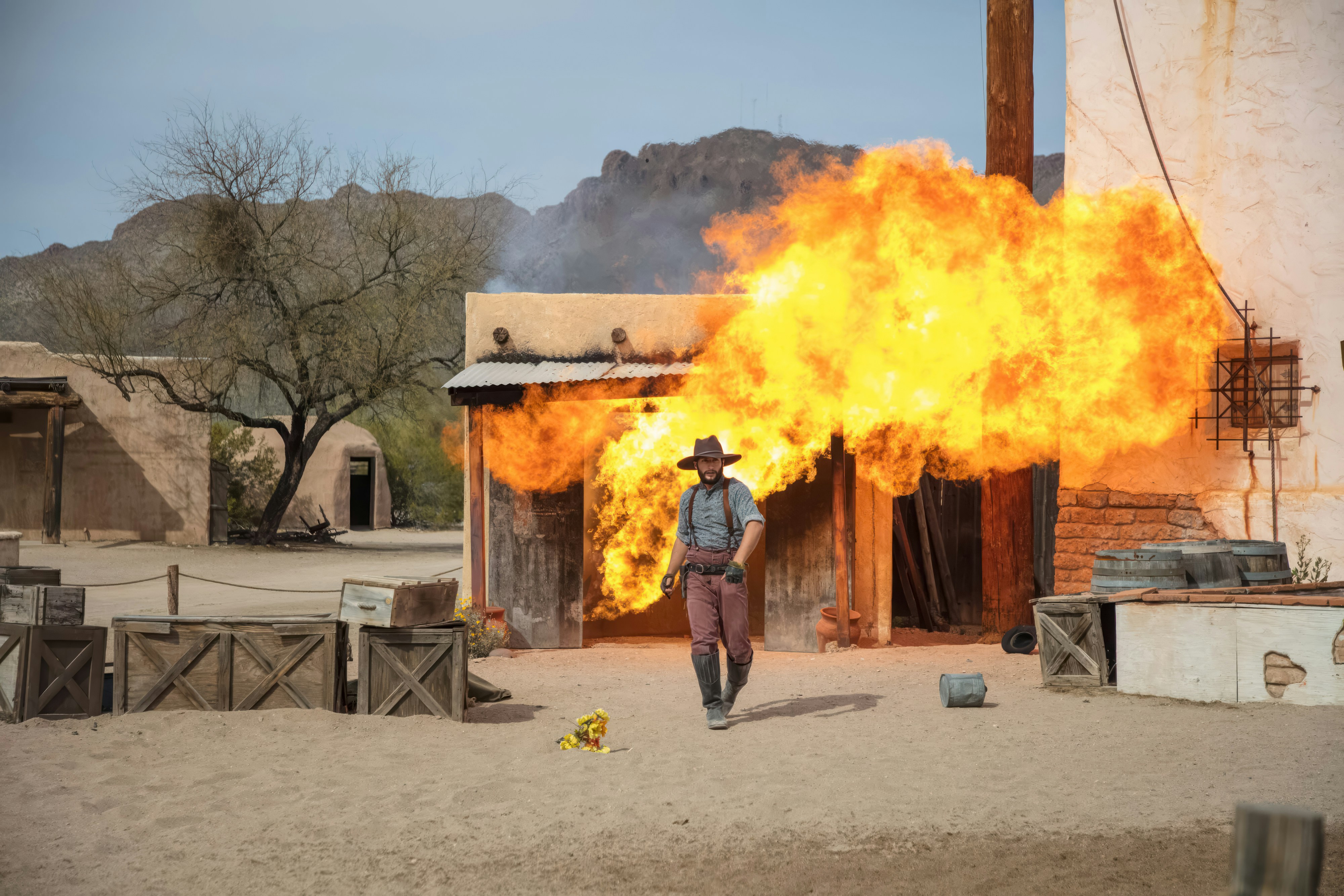 Cowboy walking away from fiery explosion on movie set photo – Free Fire ...
