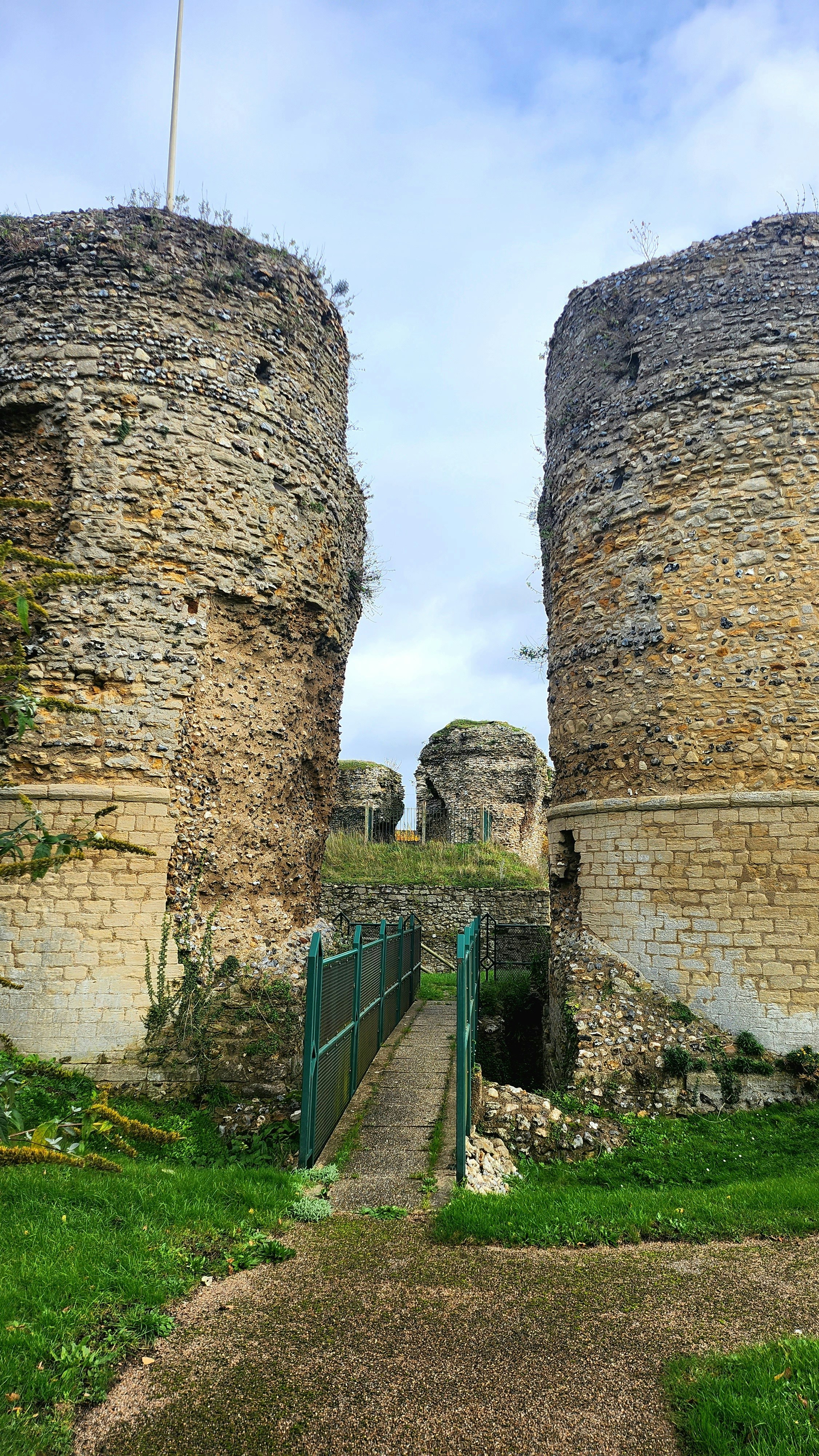 Ancient stone towers stand proudly amidst lush greenery, inviting exploration and reflection on their storied past.