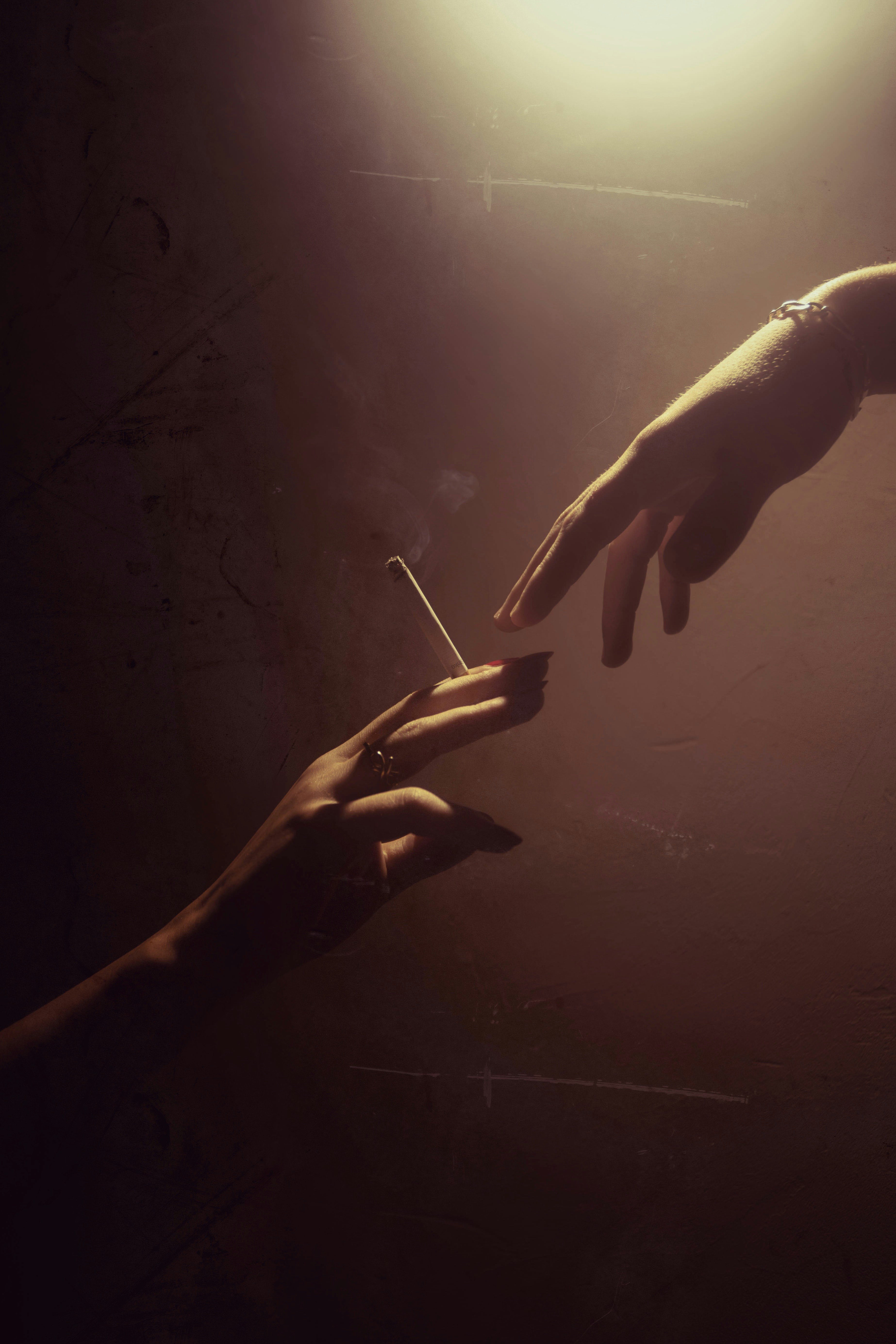 Warm Amber Hand-off: A Cigarette Pass in Low Light