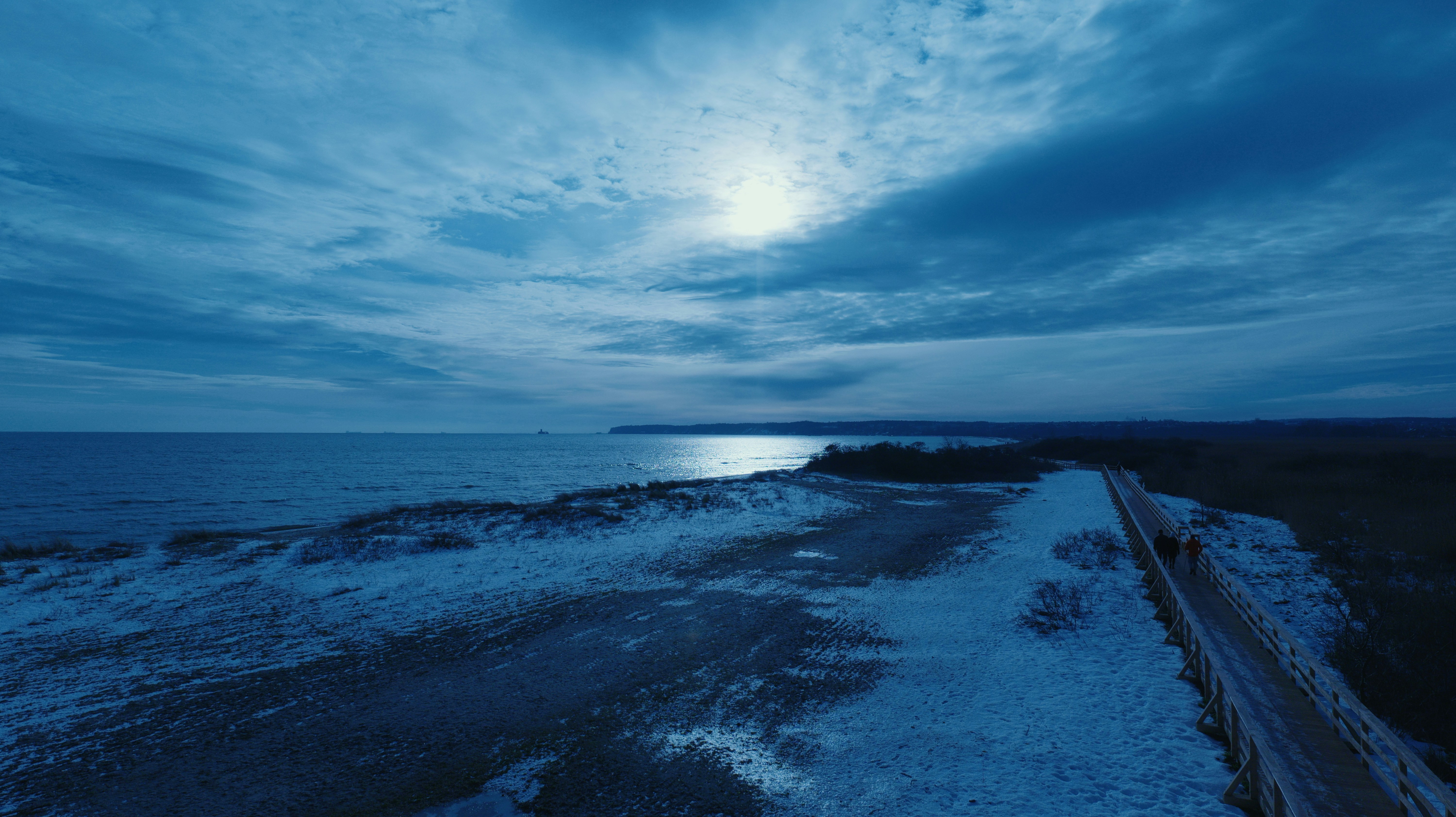 Blue Hour Breakwater: A Quiet Coastal Walk Toward the Distant Horizon