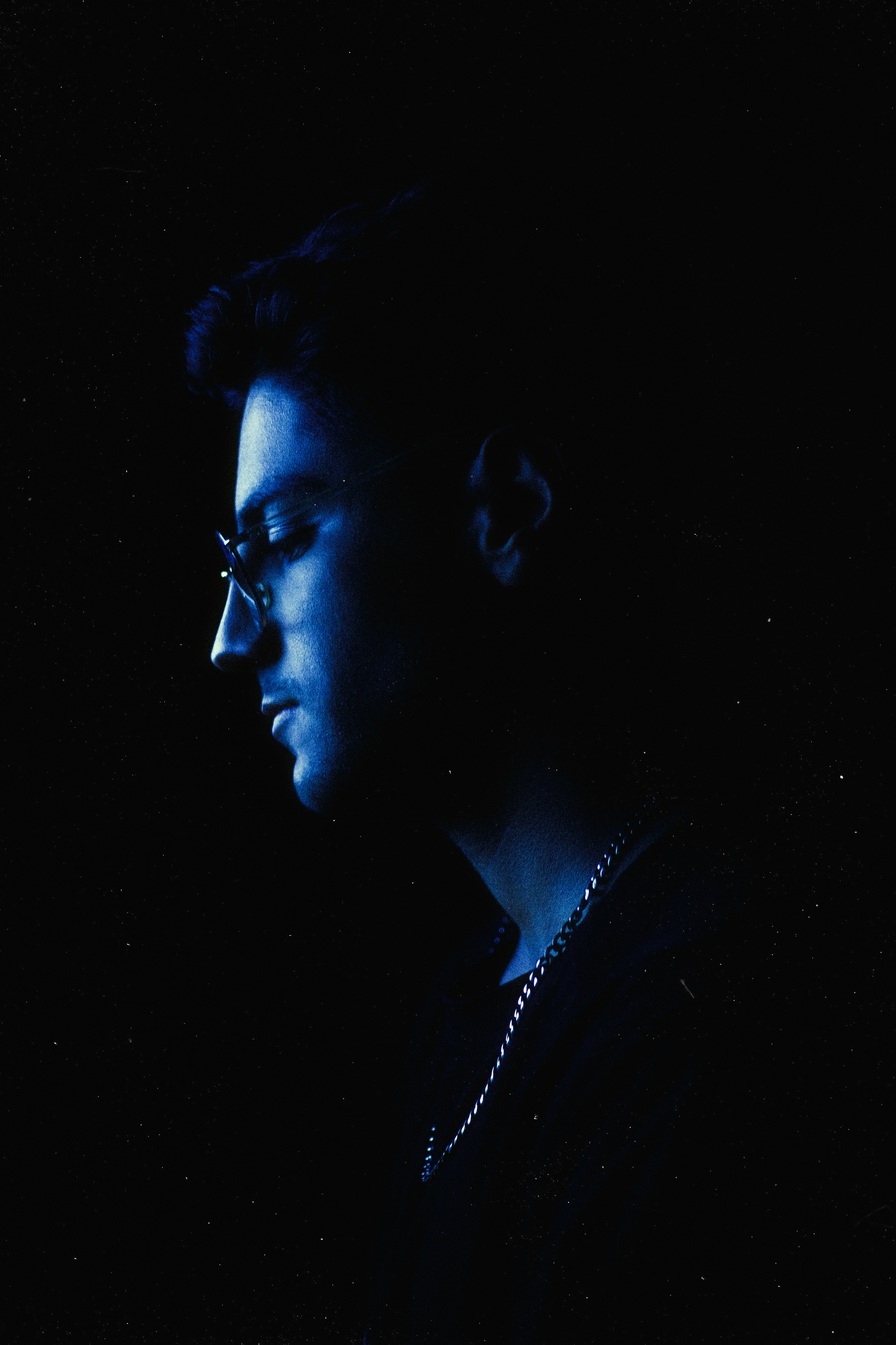 Midnight Profile: A Blue-Lit Portrait Against a Star-Dusted Backdrop