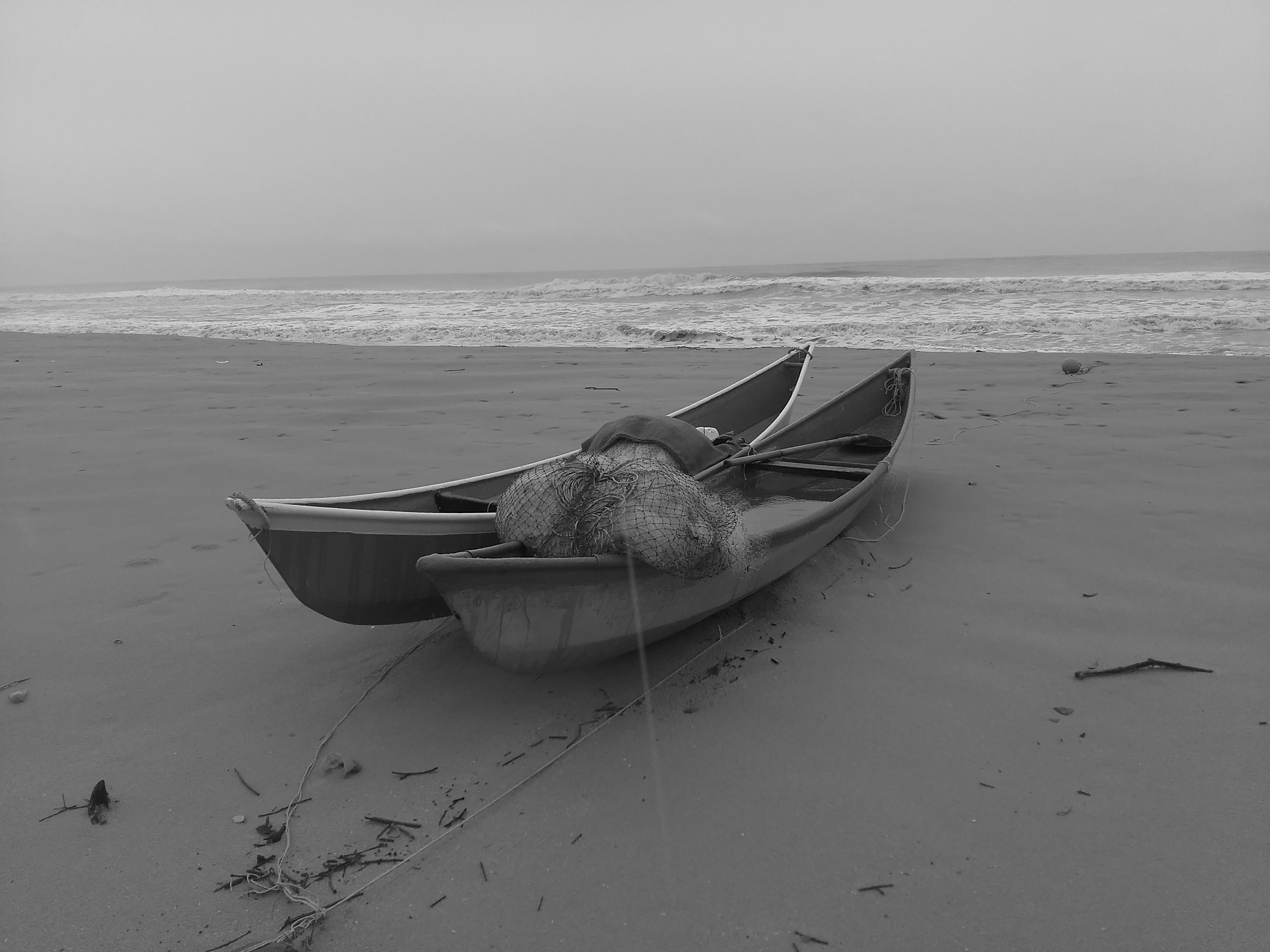 Entangled on the Desolate Shore: Three Boats at Low Tide
