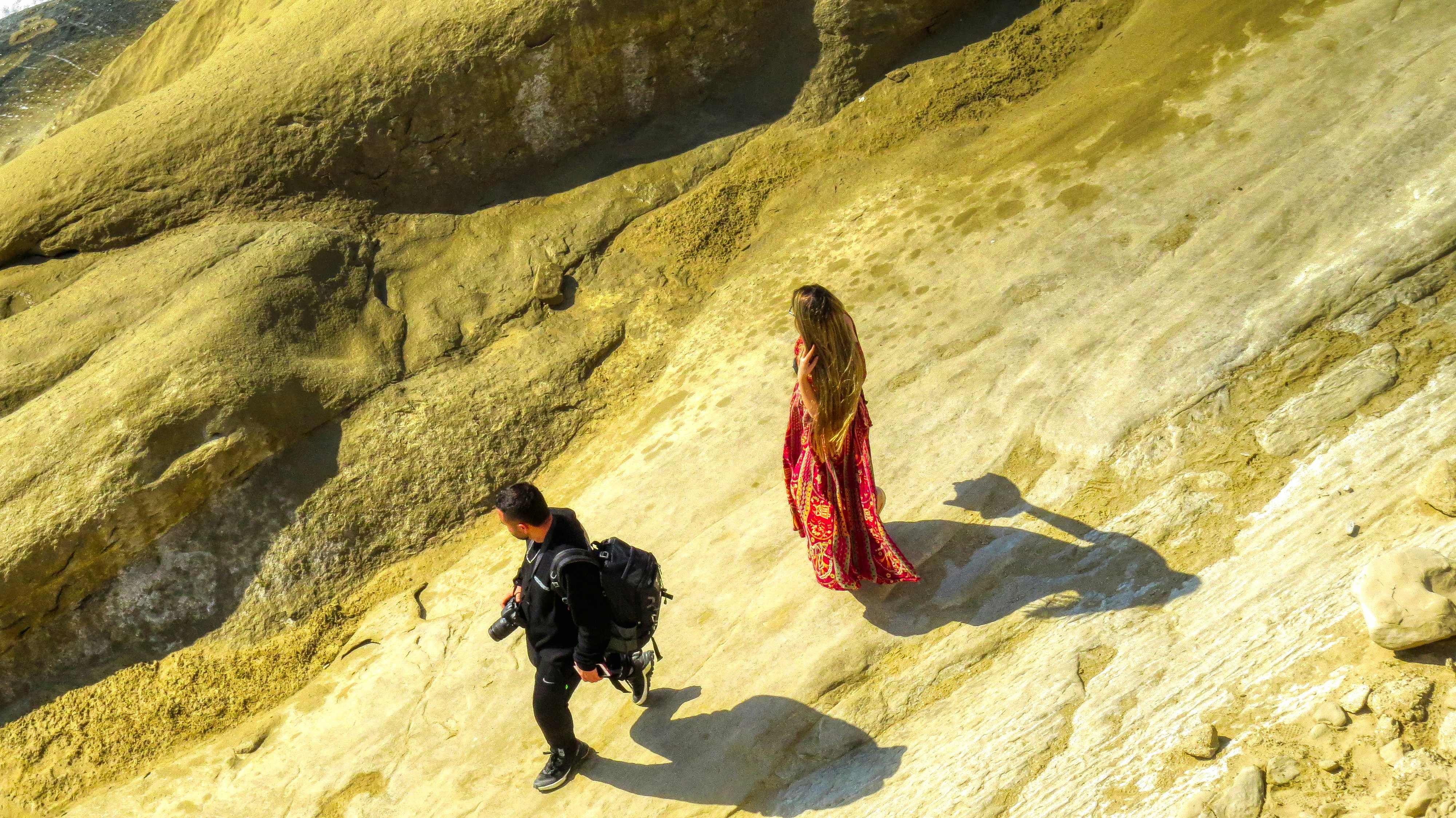a man and a woman walking up a hill