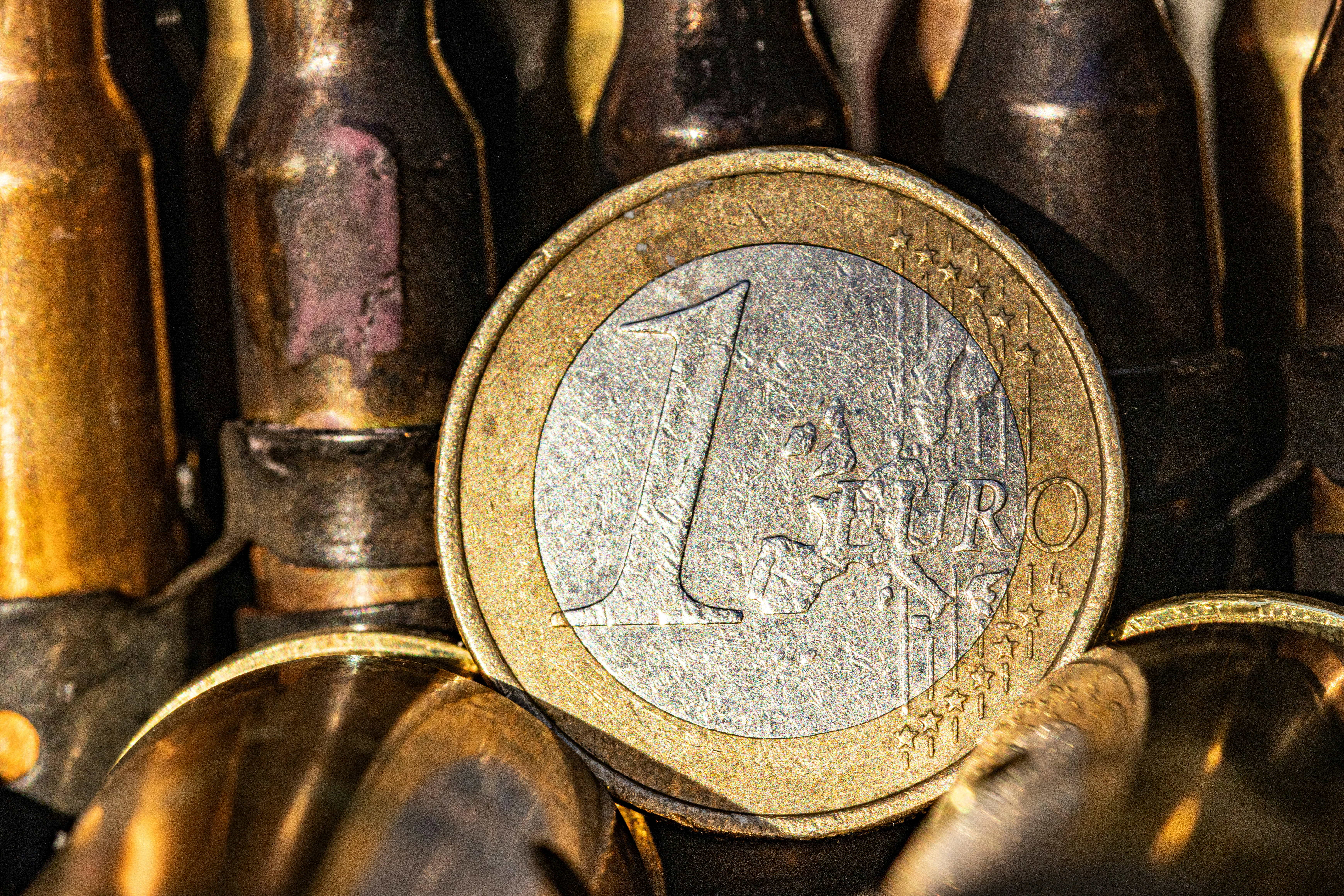 A close up of a coin surrounded by bullet shells photo – Free ...