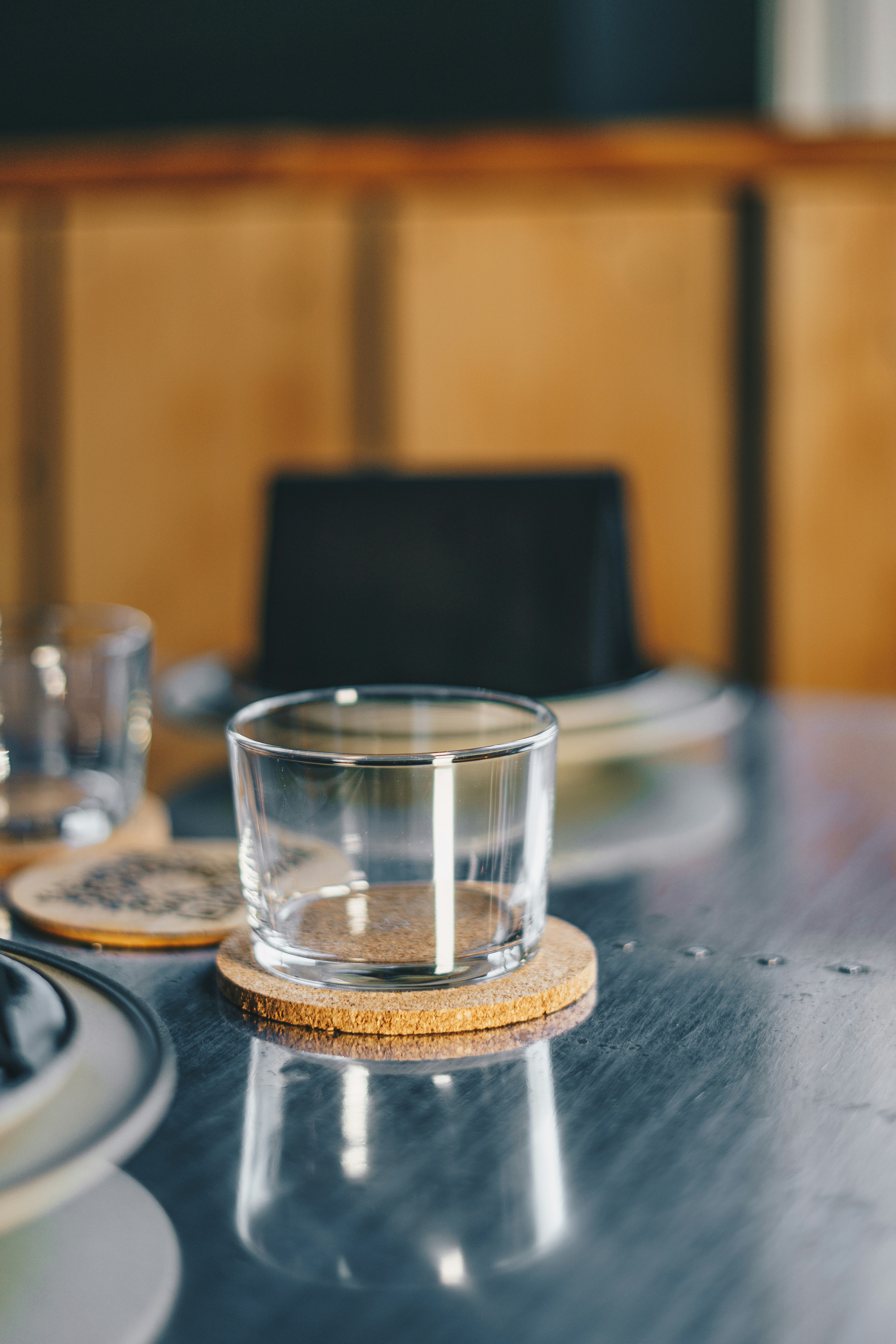 Glass on a Wooden Stage: Quiet Café Moment with a Centered Glass