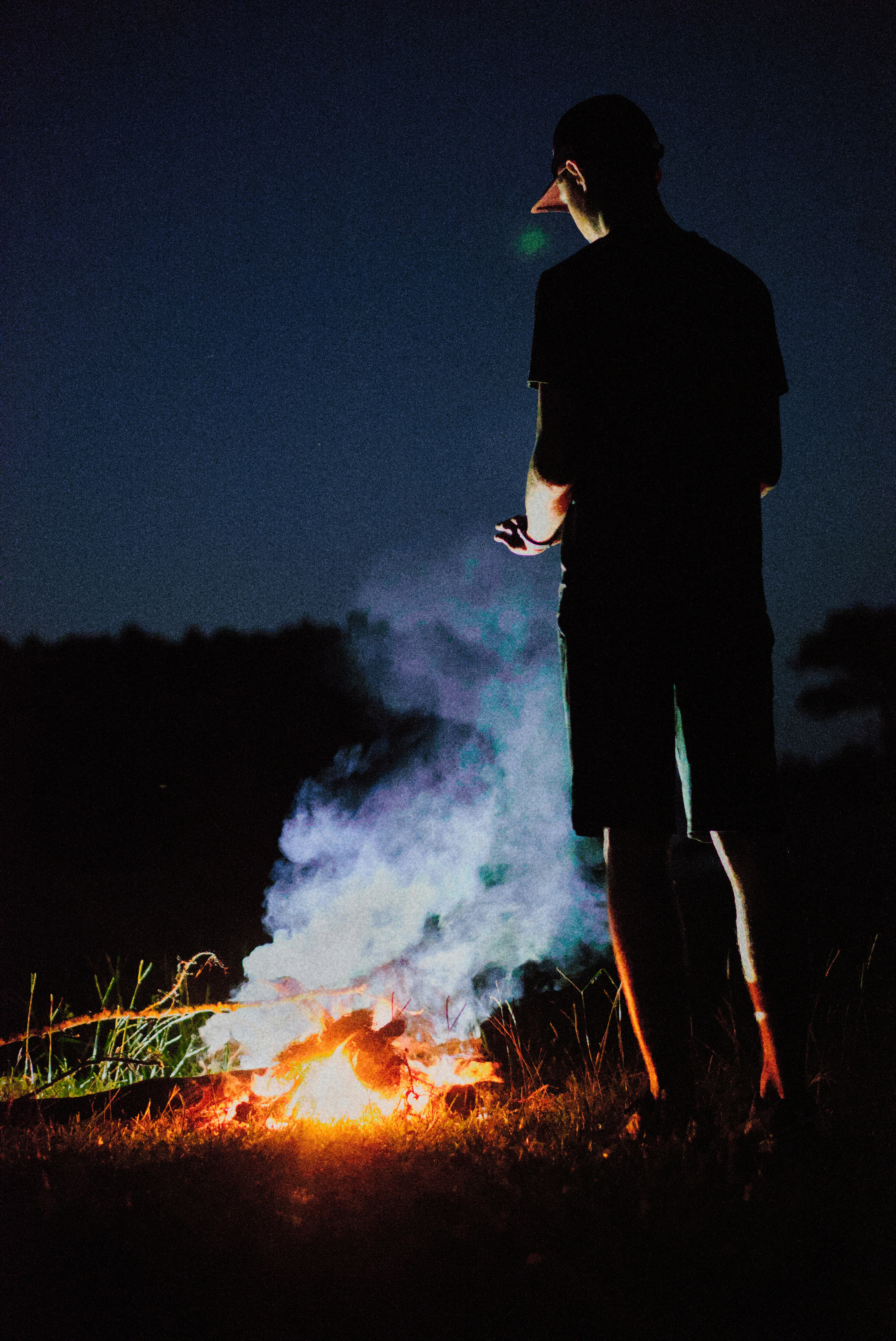 Ember-Veil: A Lone Figure by Night Fire