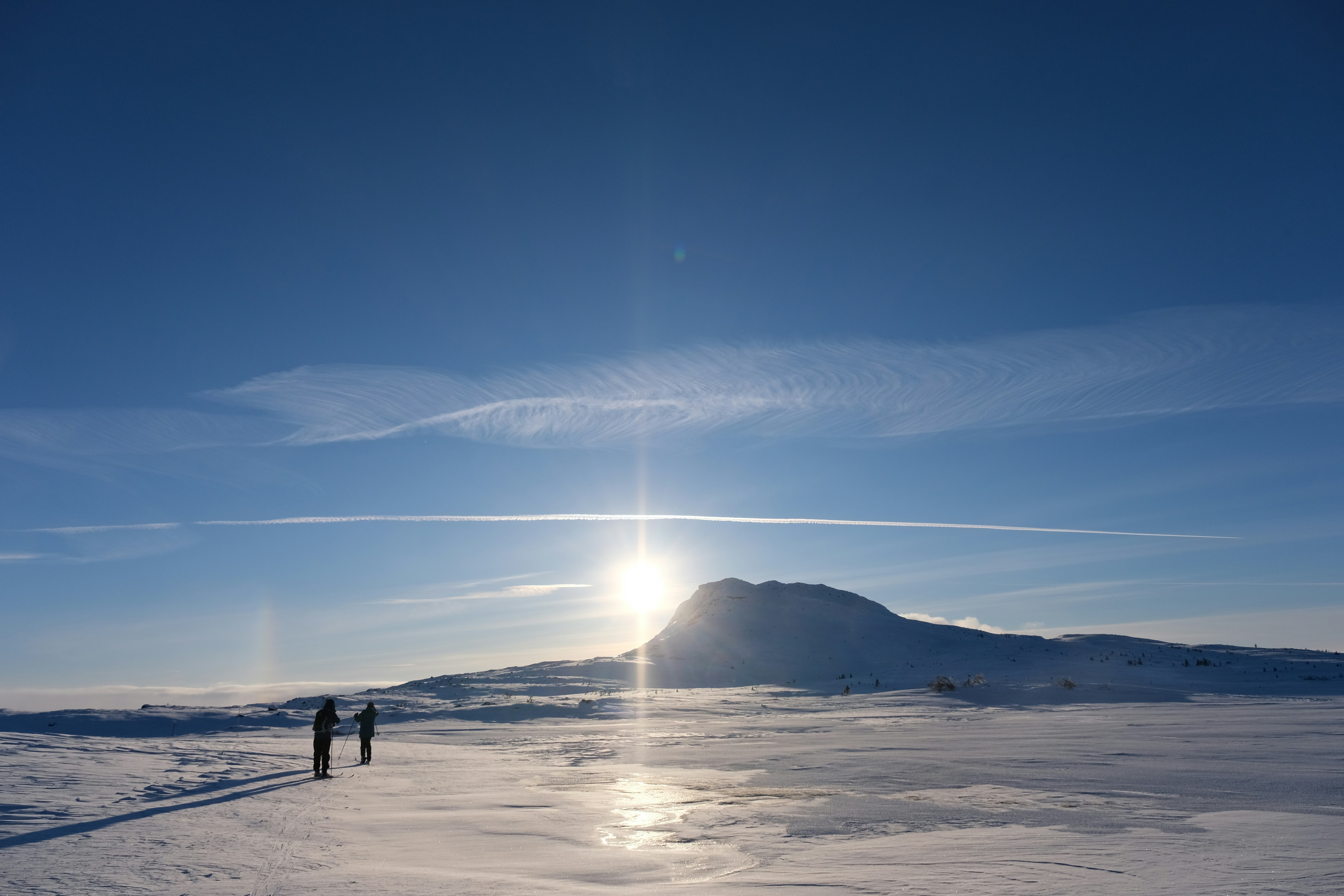 Low Sun, Wide Snow: Two Figures Walk a Polar Plain