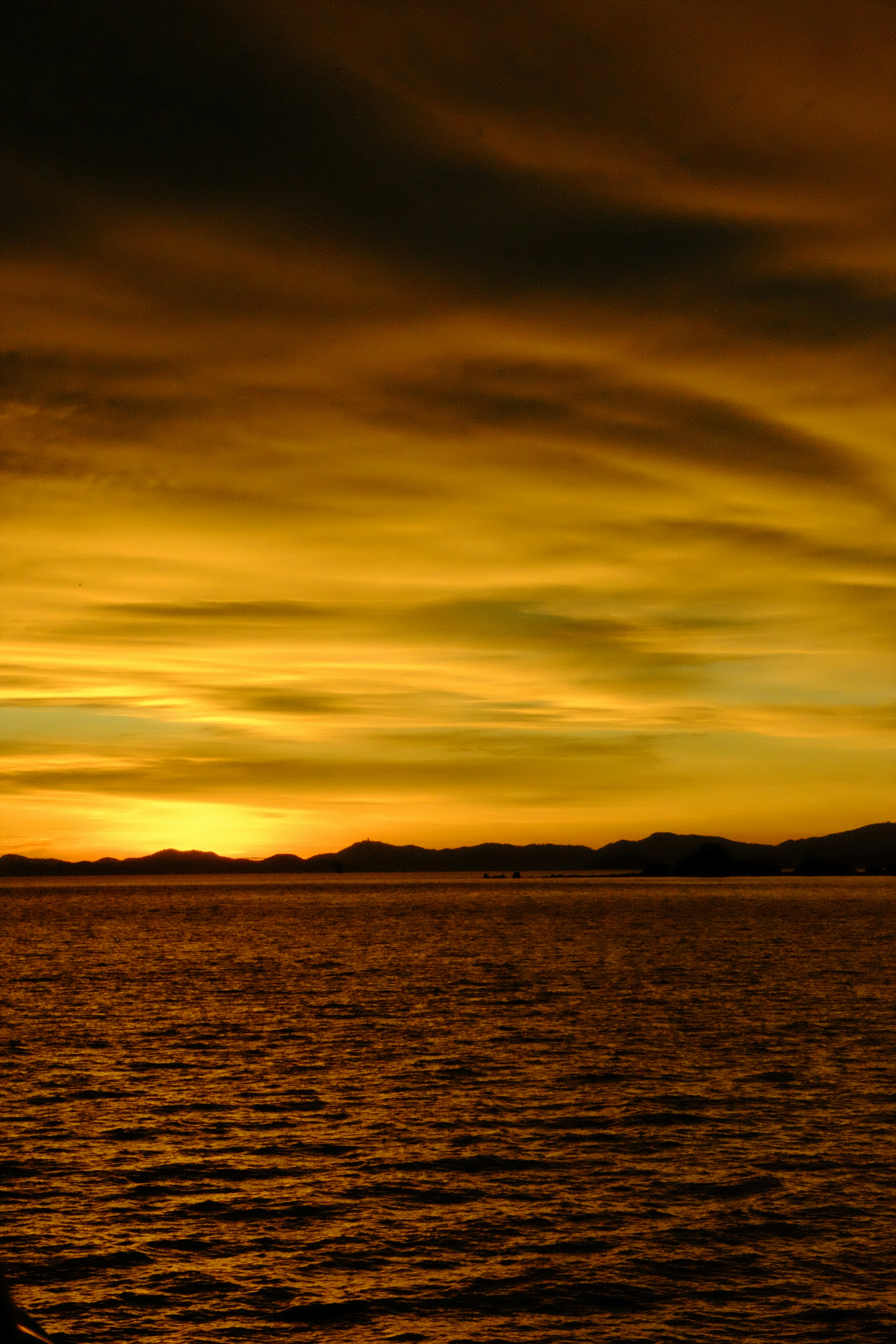 A person sitting on a boat watching the sunset photo – Free Sunset ...