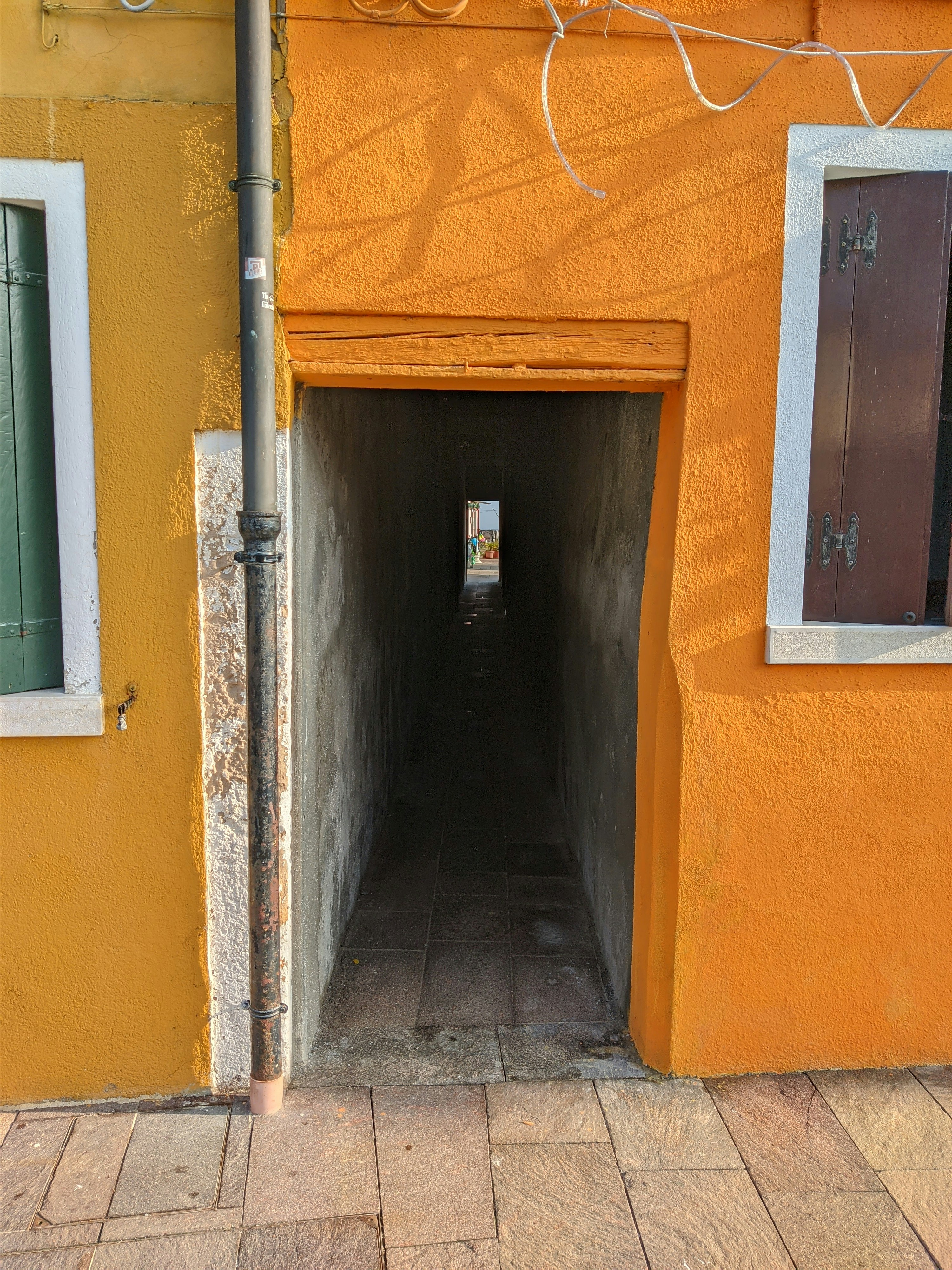Orange Threshold: A Narrow Passage Framing Distant Light