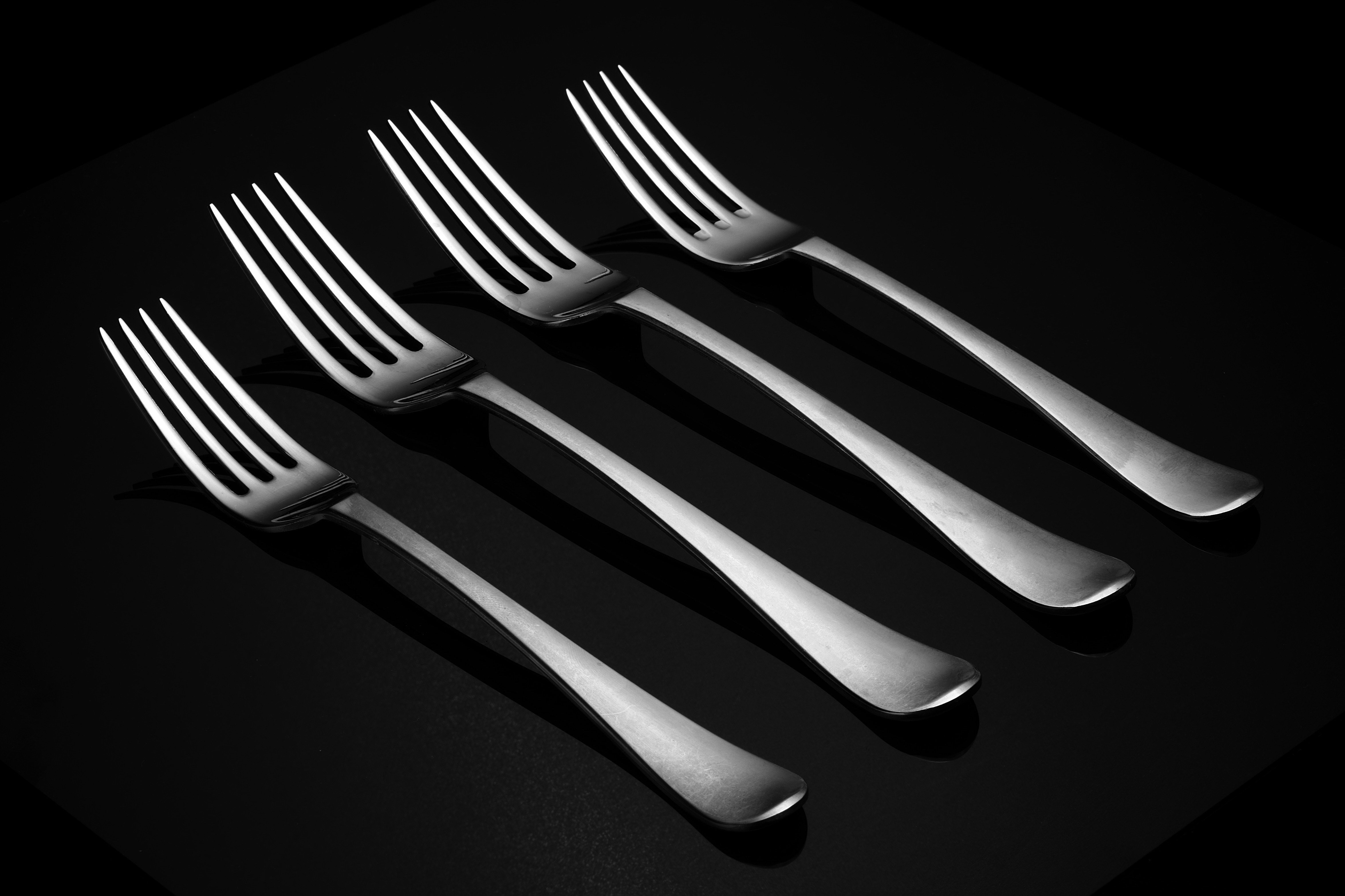 A set of four forks sitting next to each other photo – Free Cutlery ...