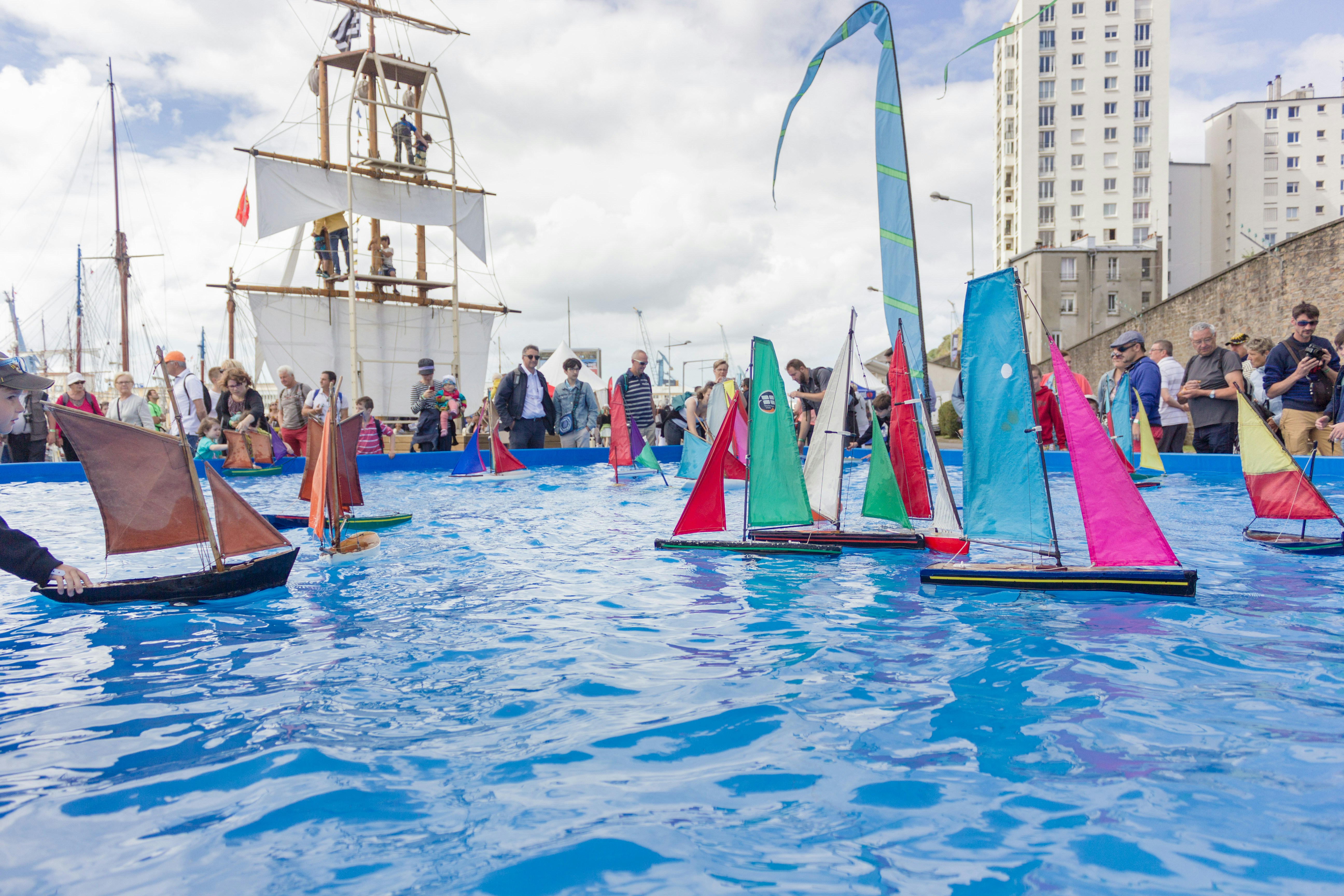 Mini Sailboats, Major Crowd: A Waterfront Playground of Colorful Pressurized Sails