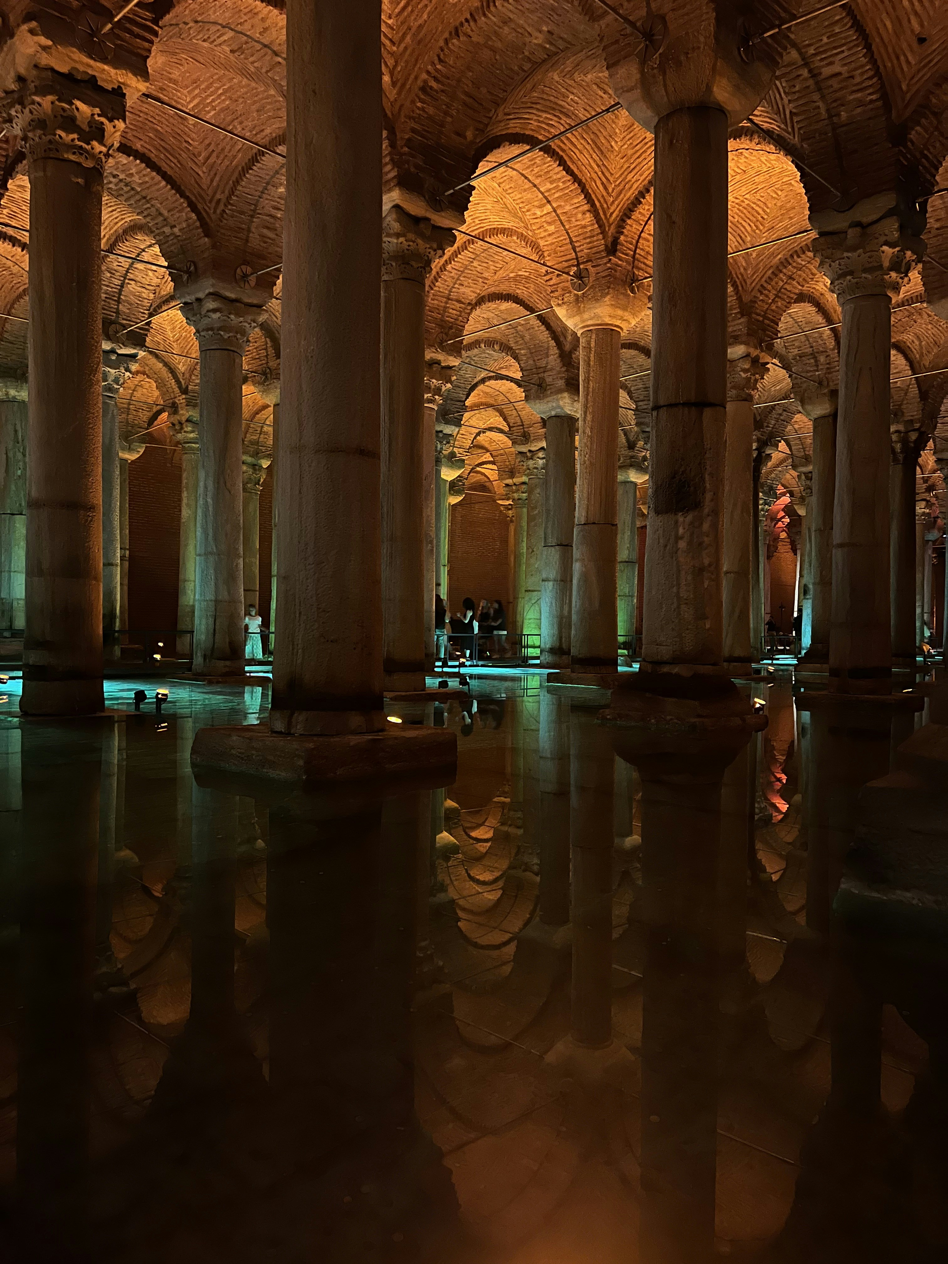 A person standing in a large room with columns photo – Free Pillars ...