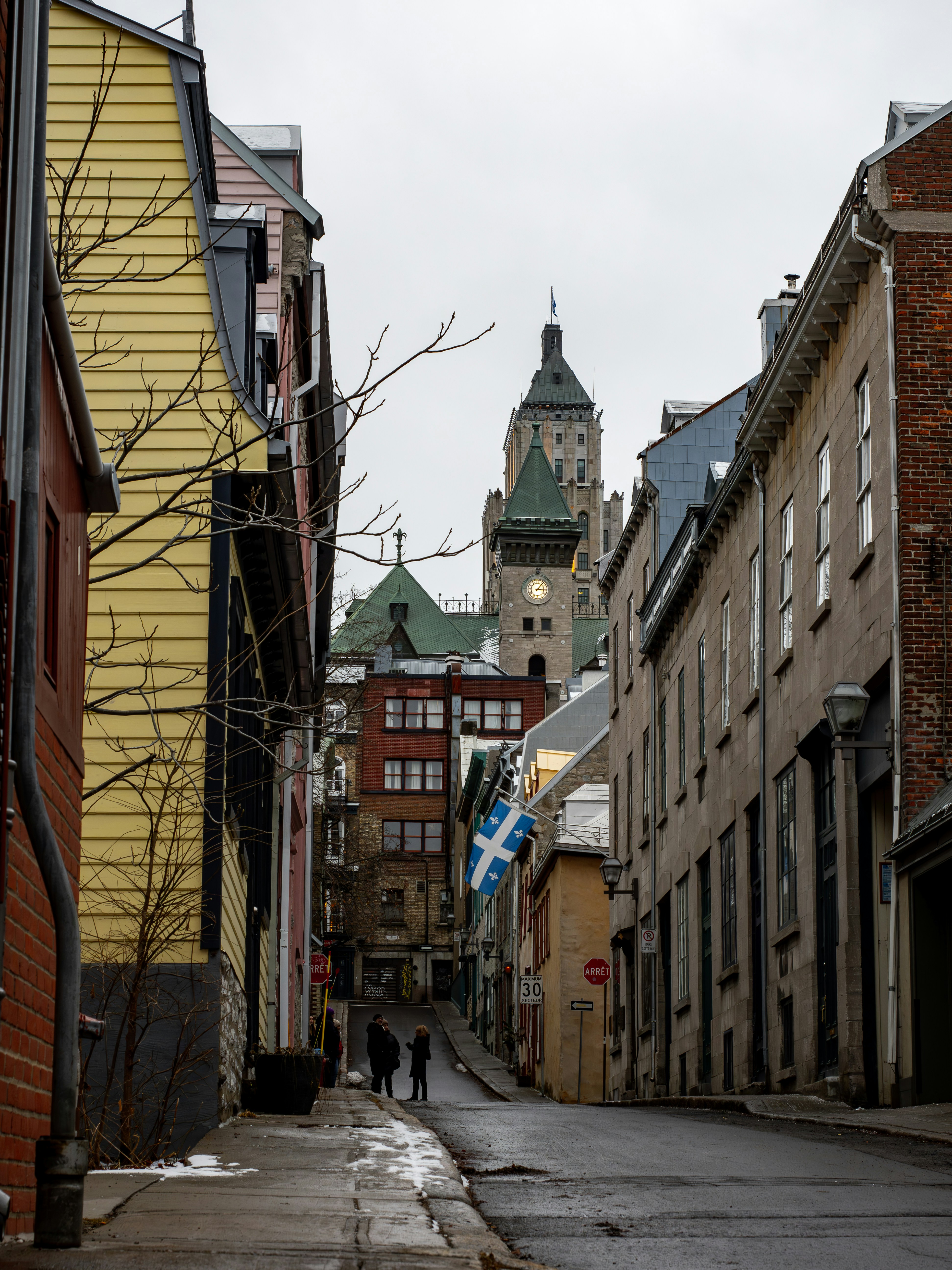Clocktower Horizon: A Quiet Street Framing a Green-Roofed Spire