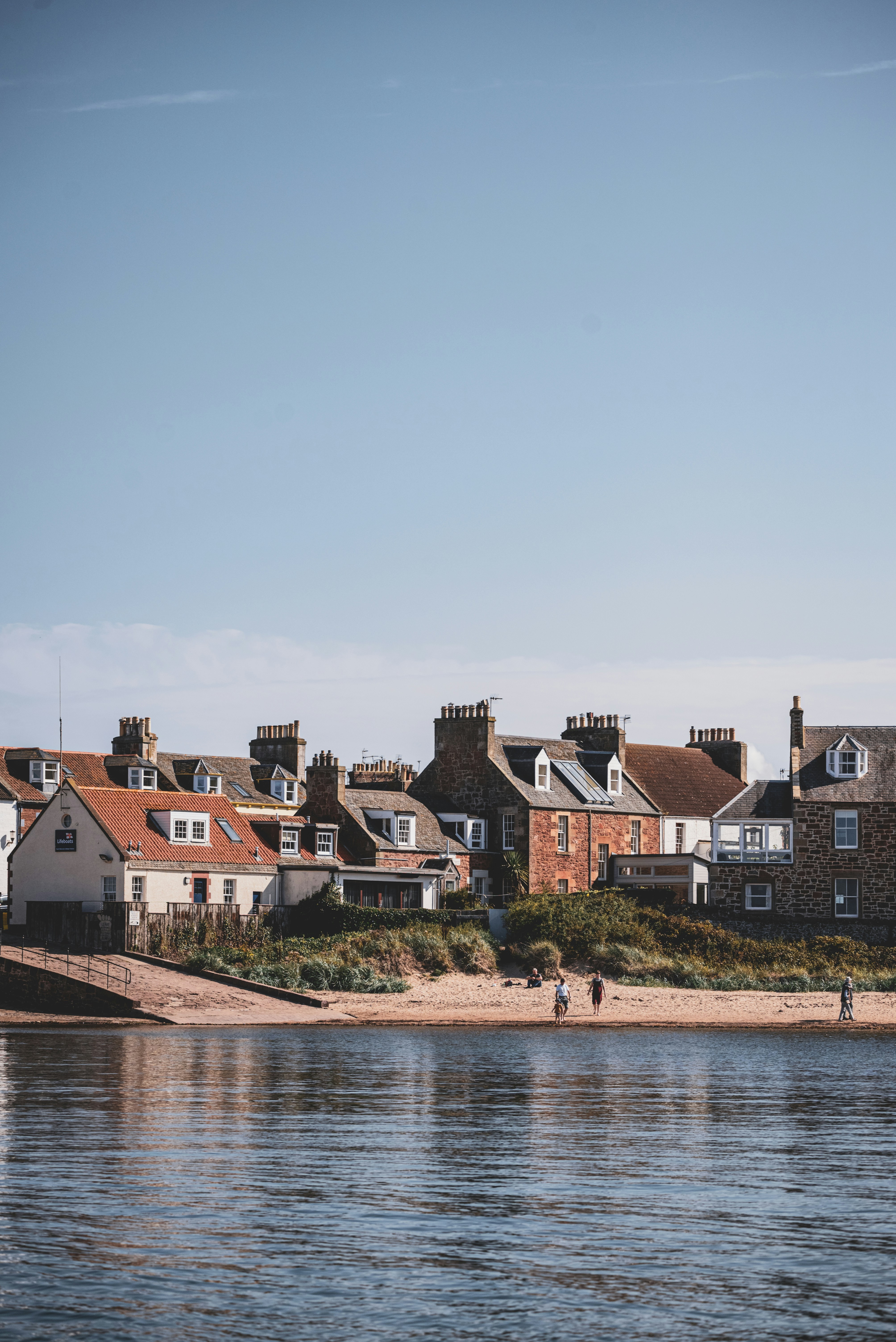 Chimneyed Cottages Along a Quiet Seaside, Reflections on a Glassy Channel