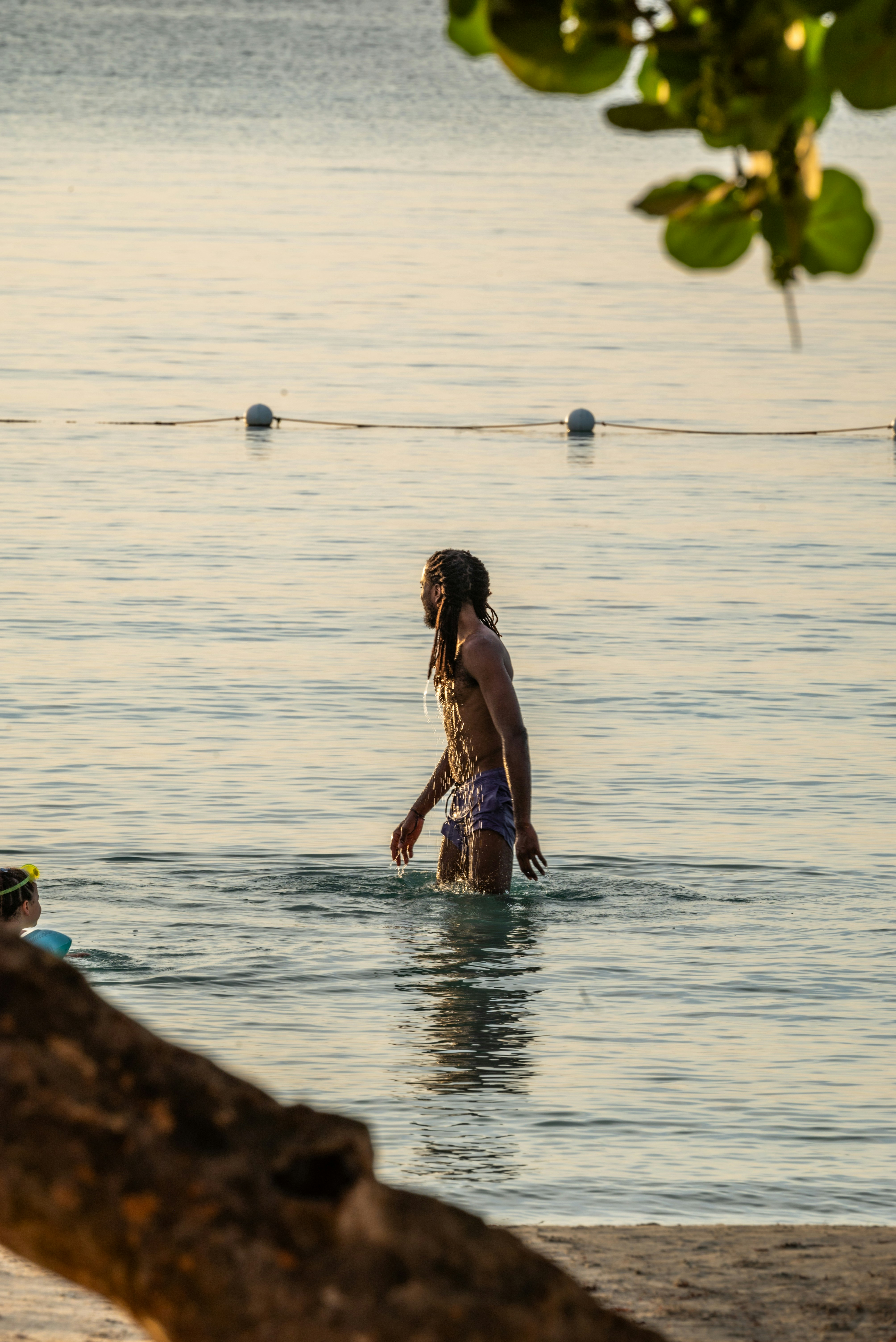 Golden Hour Lonesome: A Swimmer Wanders the Quiet Shore