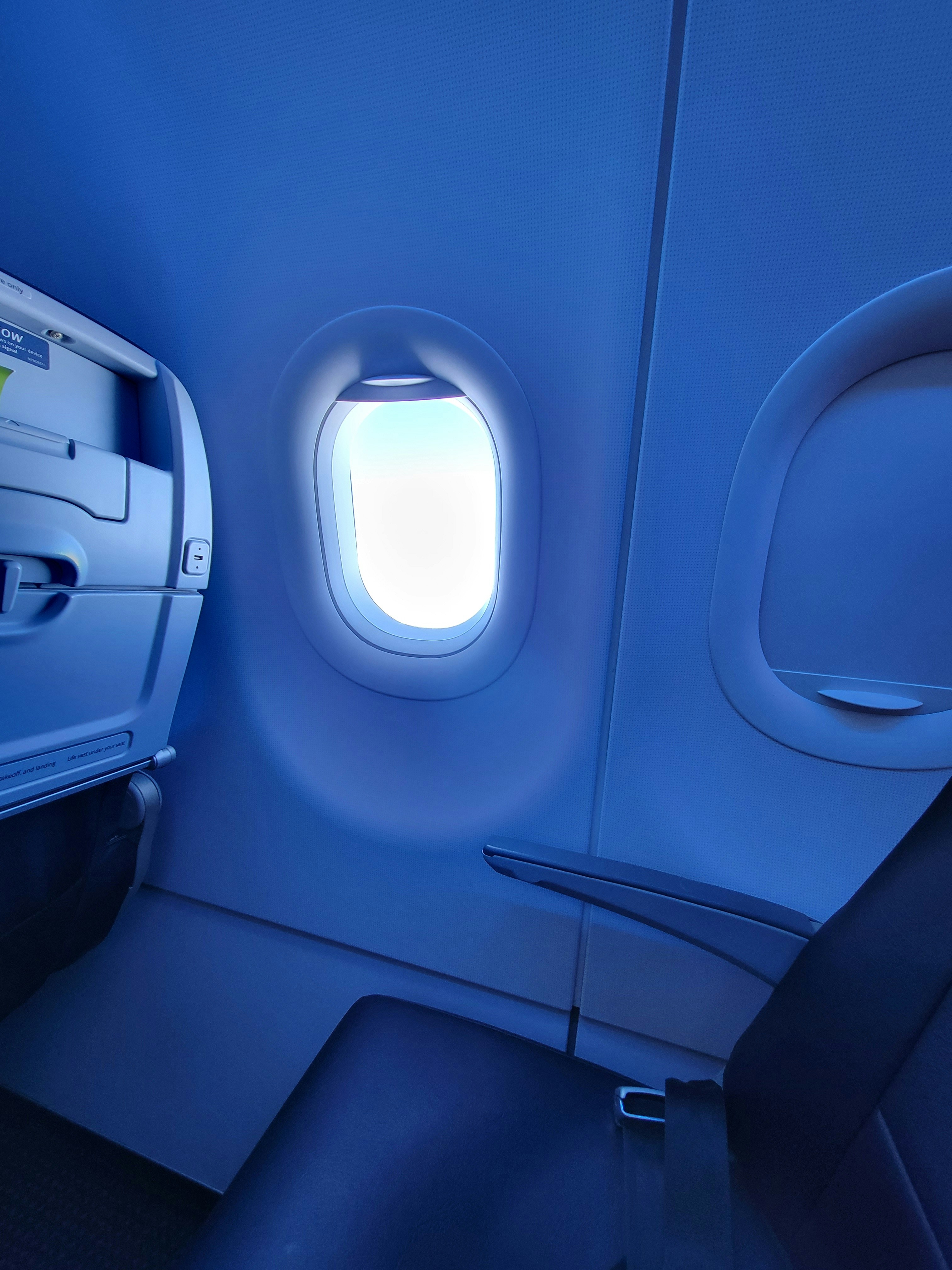 the inside of an airplane with a windowHaripriya K