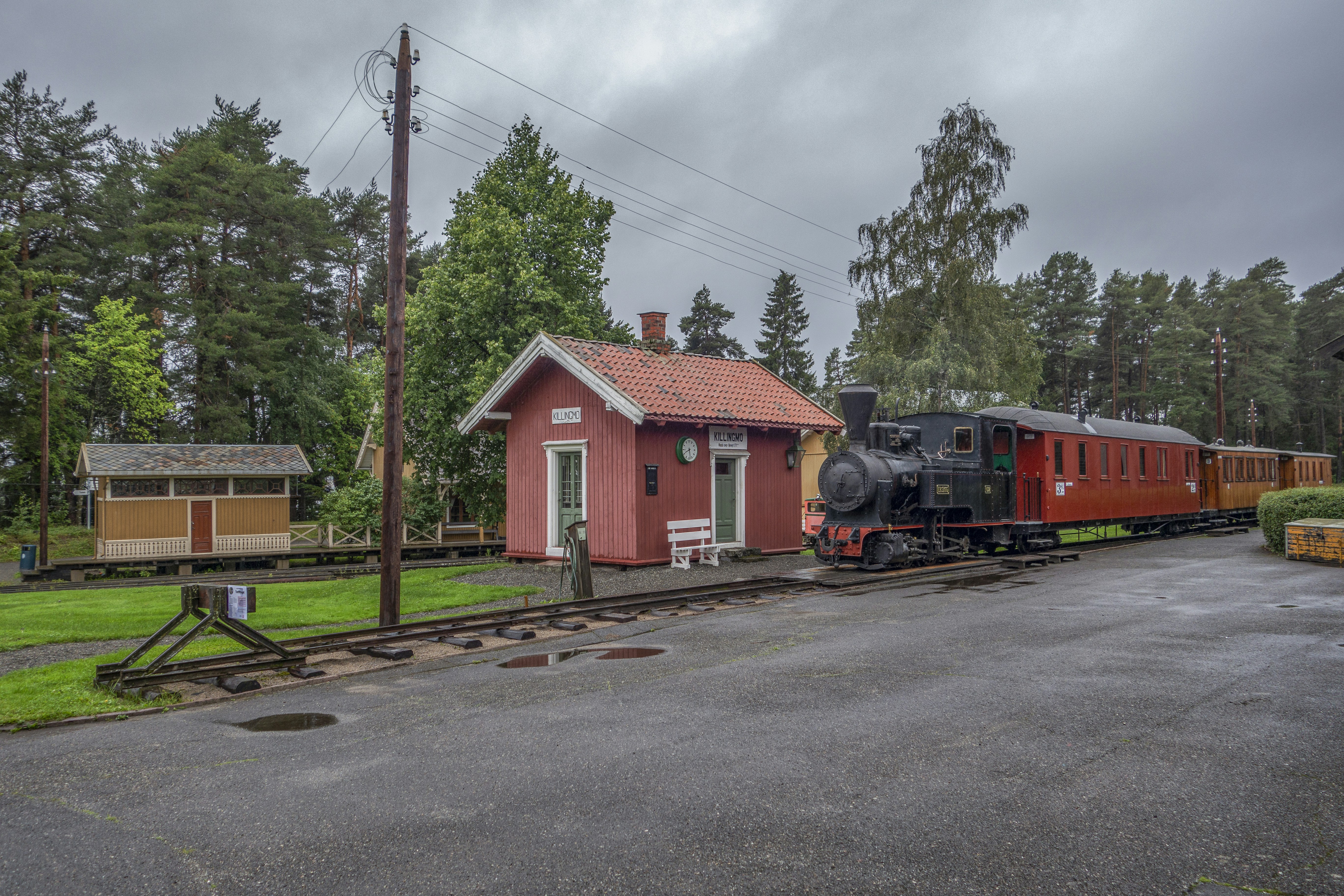 A small train station with a train on the tracks photo – Free Train ...