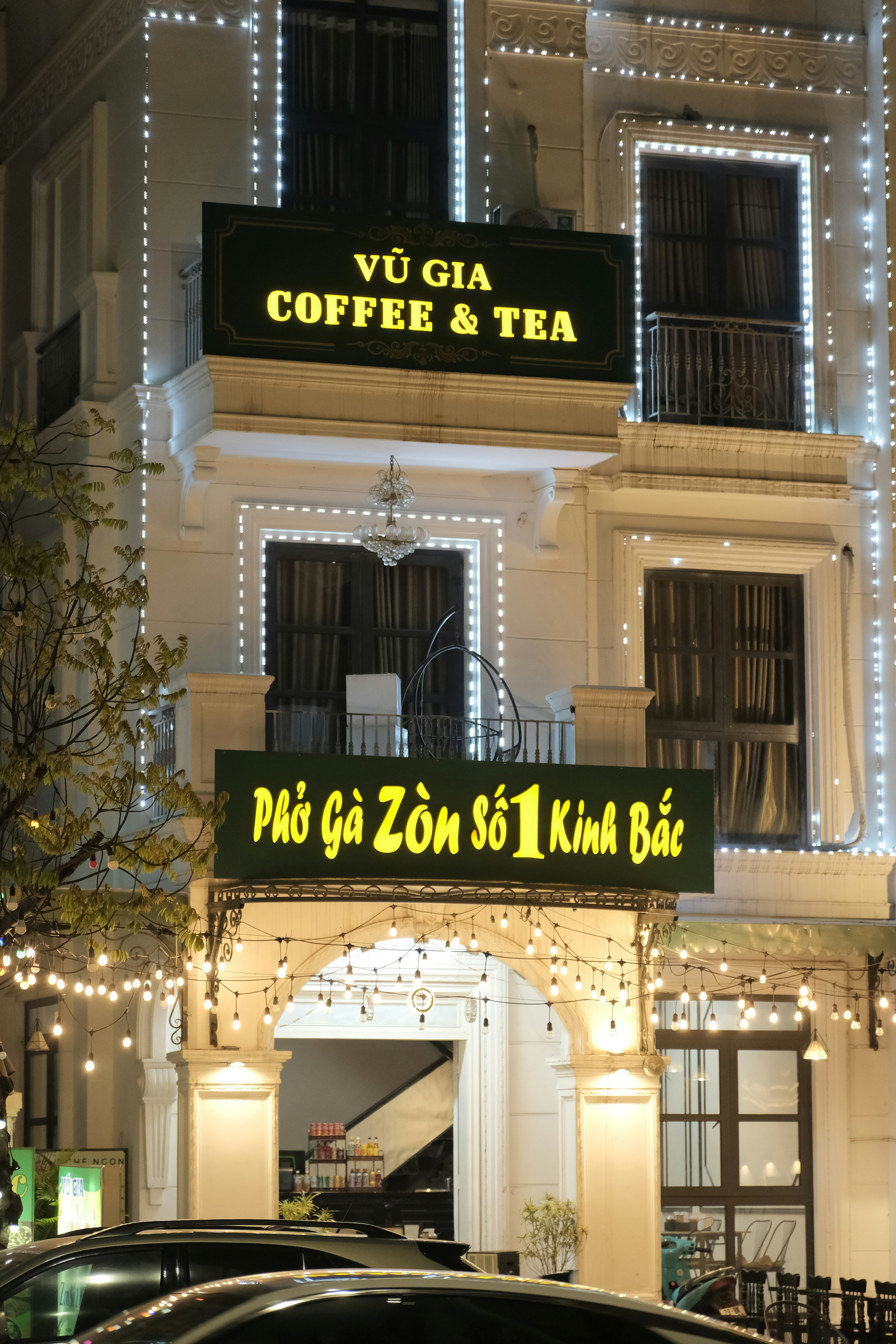Vũ Gia Coffee & Tea: Neon Outline on a Nighttime Façade