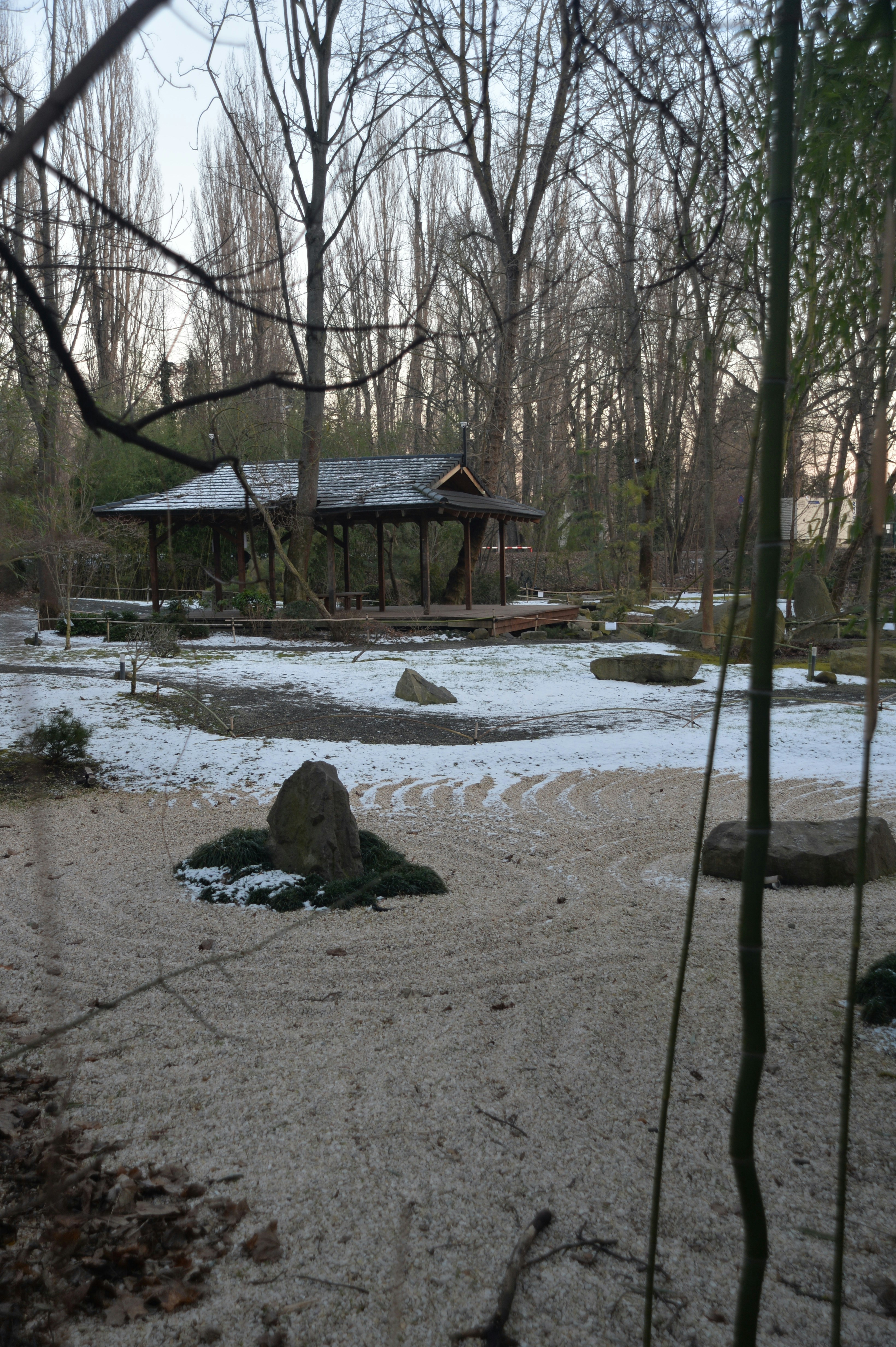 Winter Shelter: Quiet Pavilion Among Snow-Kissed Gravel