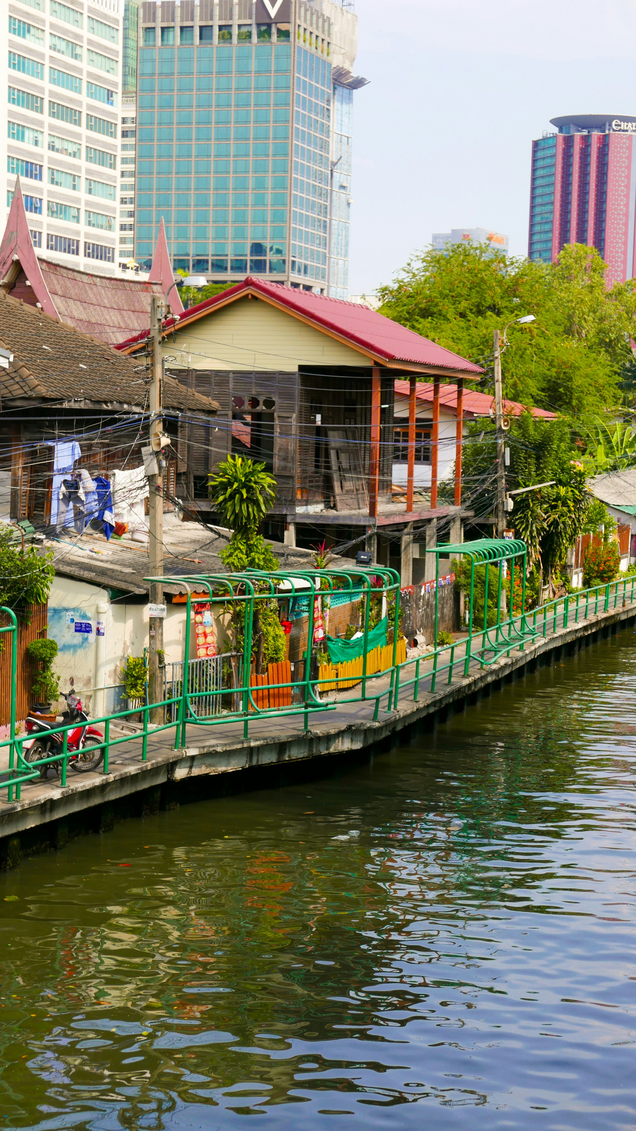 Canalfront Timber House Amid a Glass Skyline