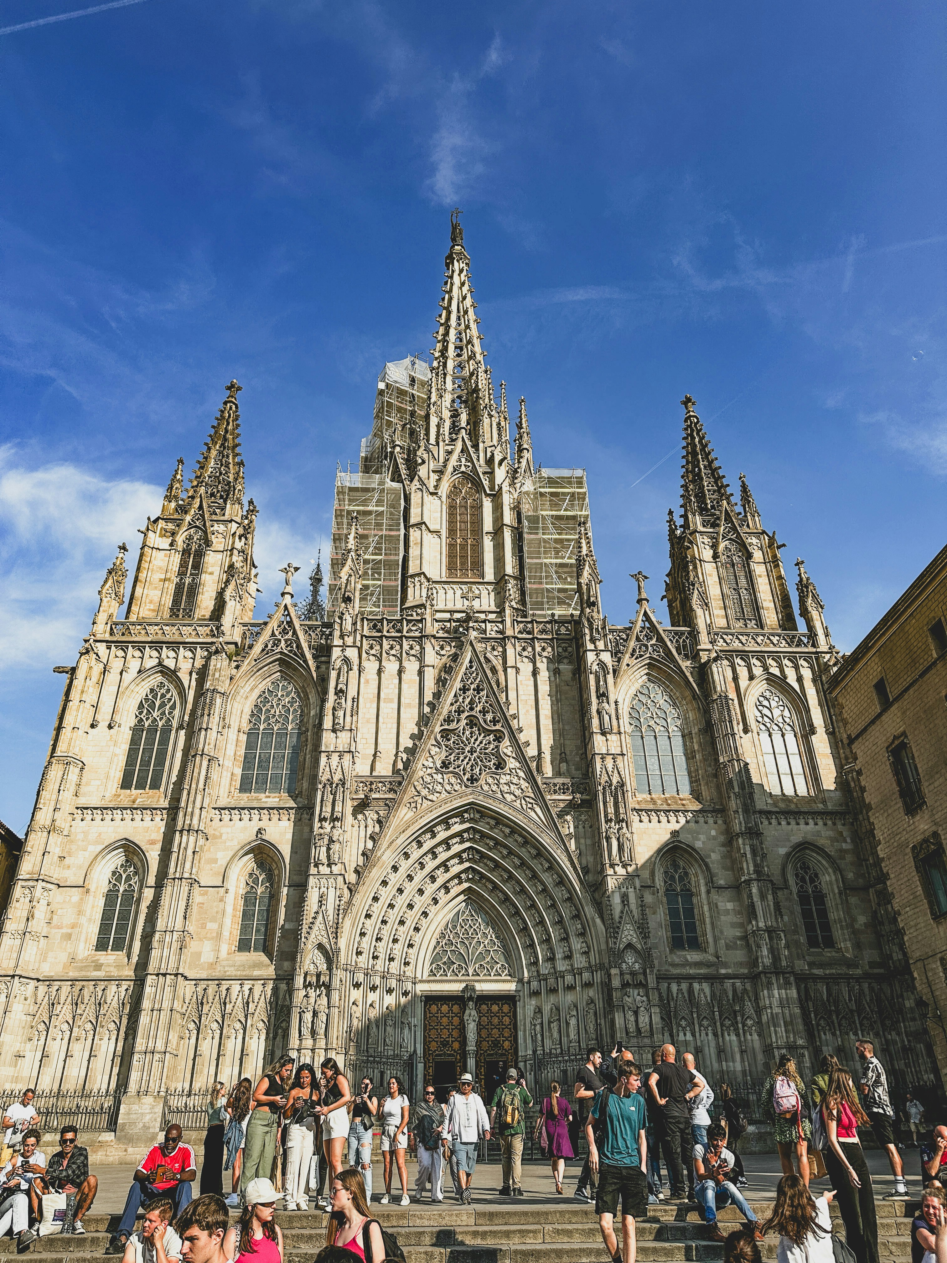 Spire and Steps: Gothic Cathedral Framed by a Crowded Forecourt