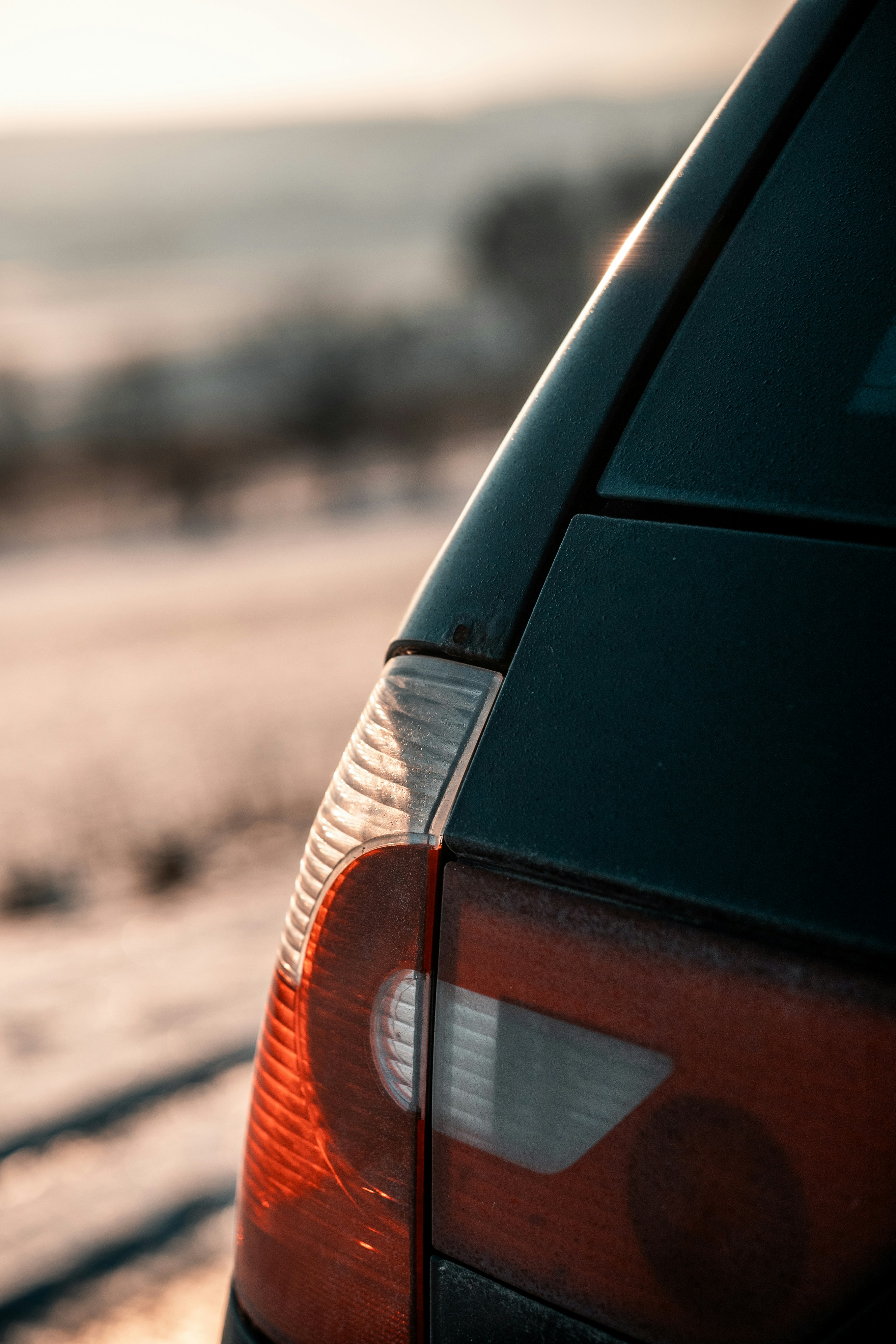 Golden Hour Edge: A Tail Light Framed by Dune Light