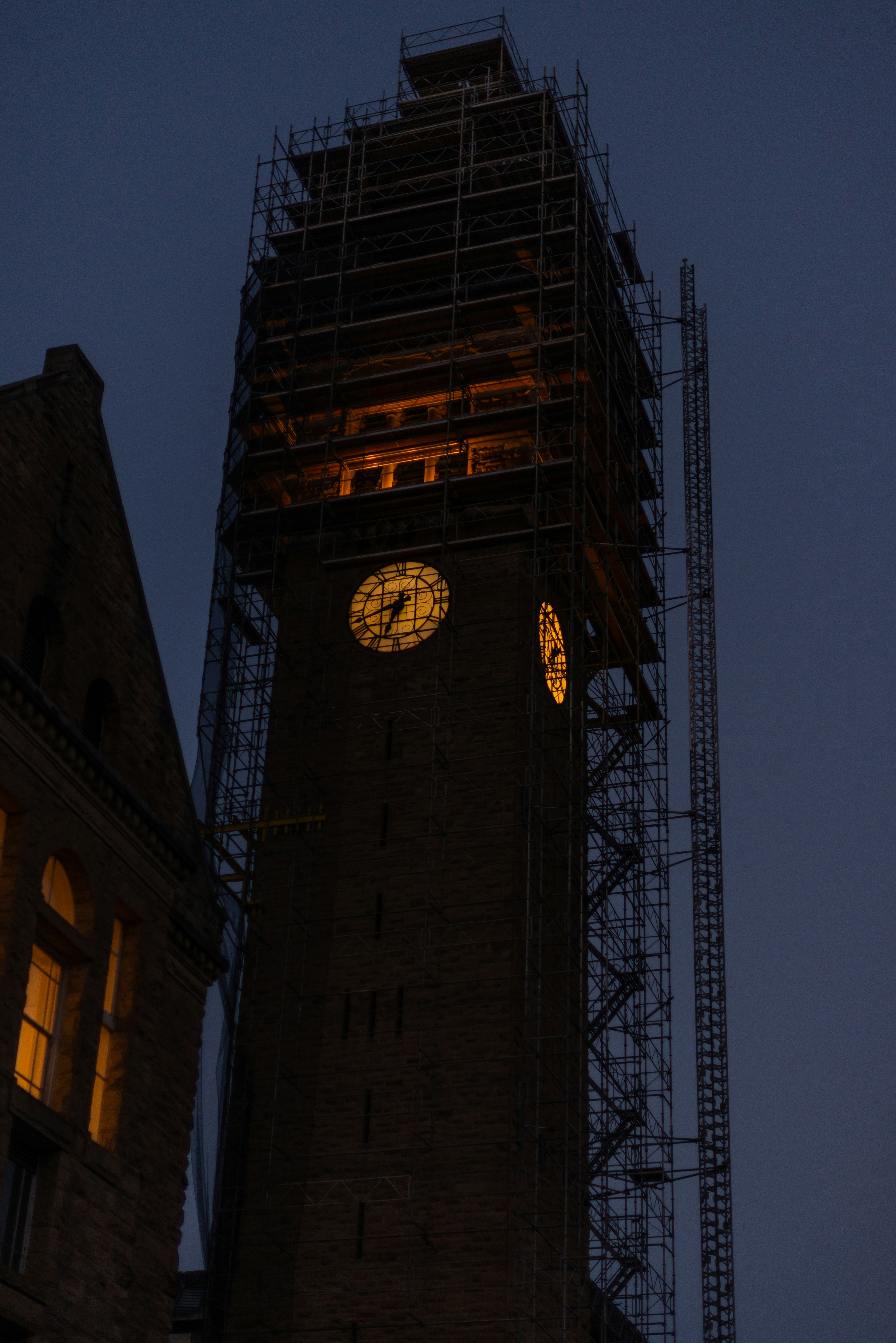 A clock tower with scaffolding around it at night photo – Free Cornell ...